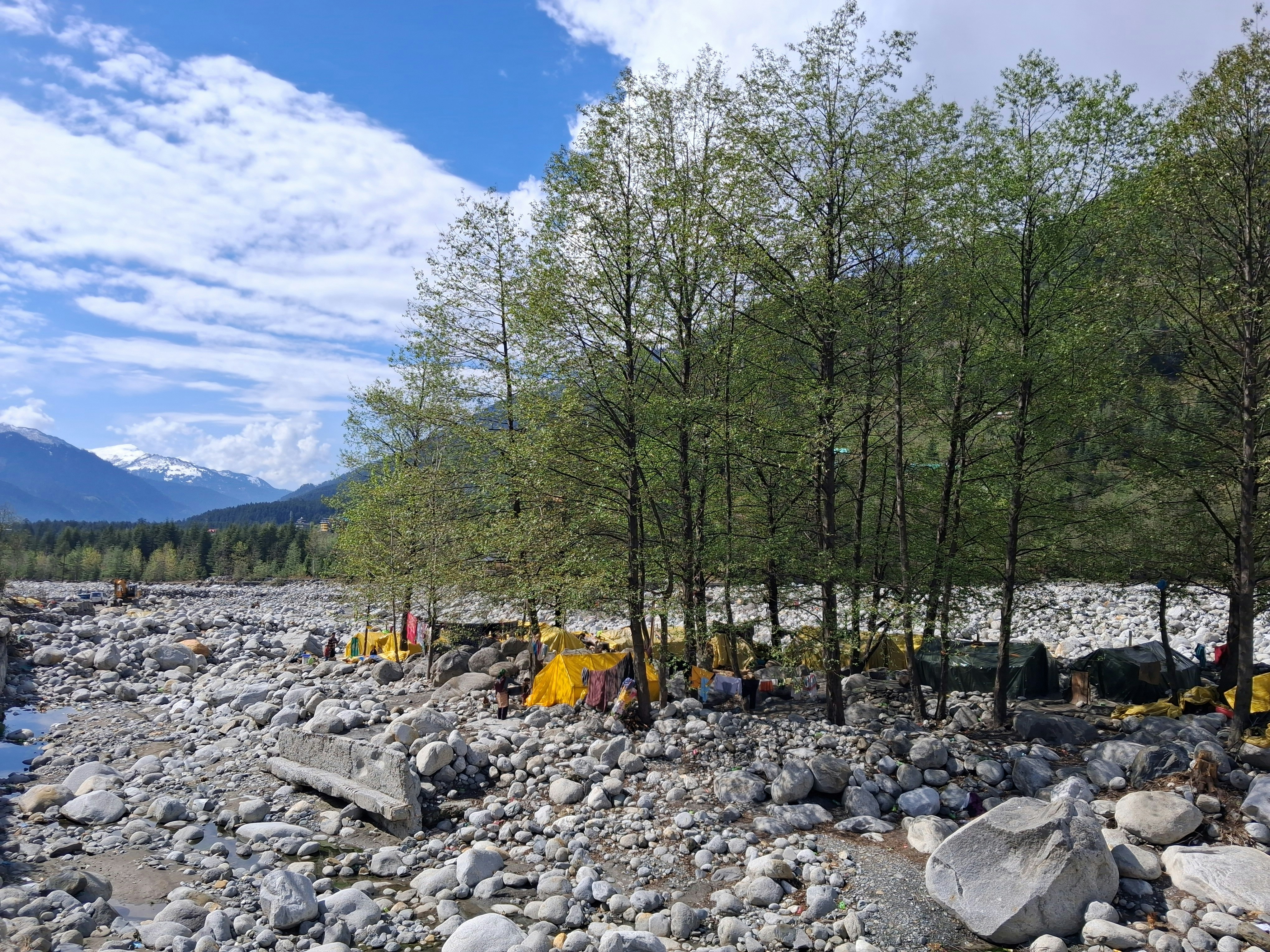 Rugged riverside camp beneath spring skies