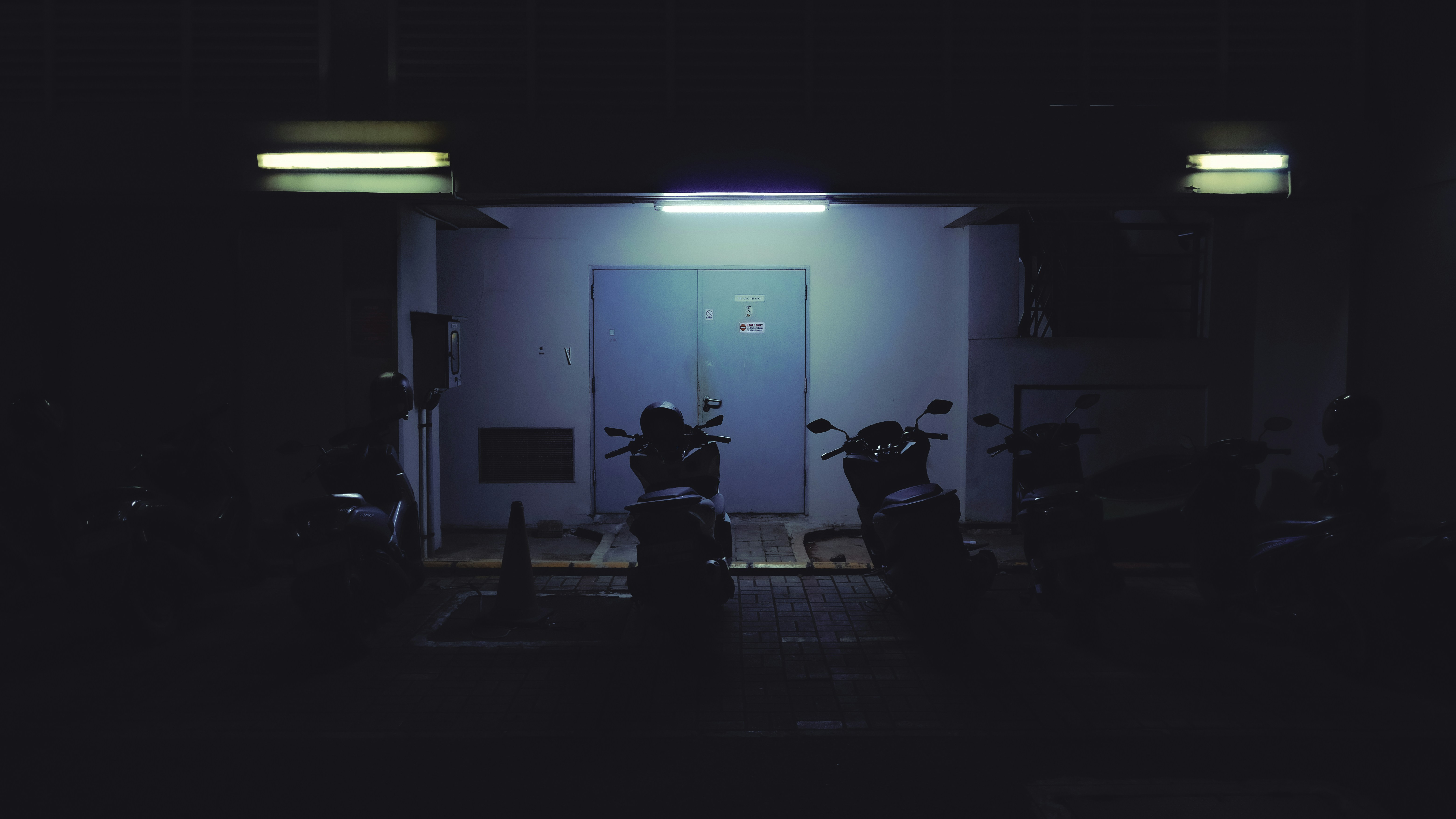 Blue Door Under Neon: Night Shuttle Parking