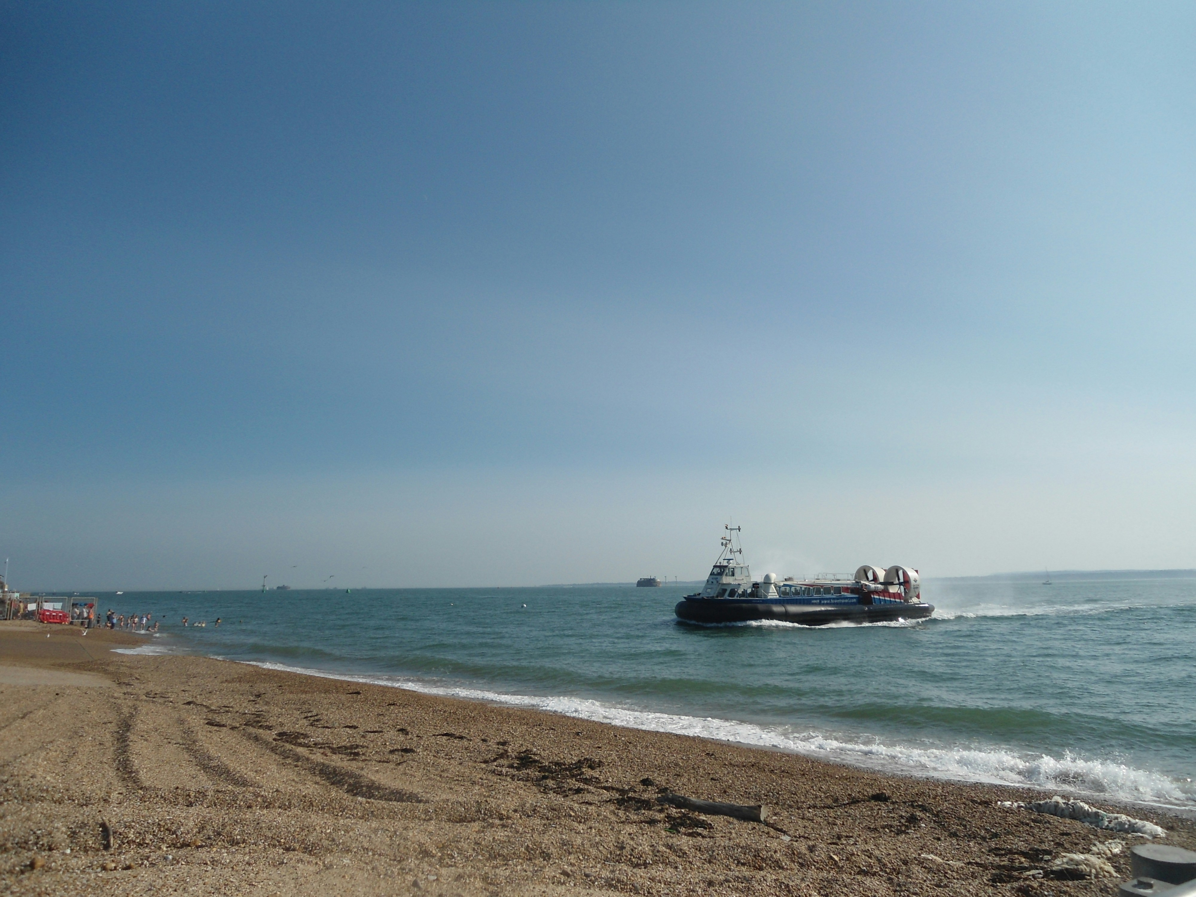 Coastline Arrival: Harbor Tug Crossing a Calm Day