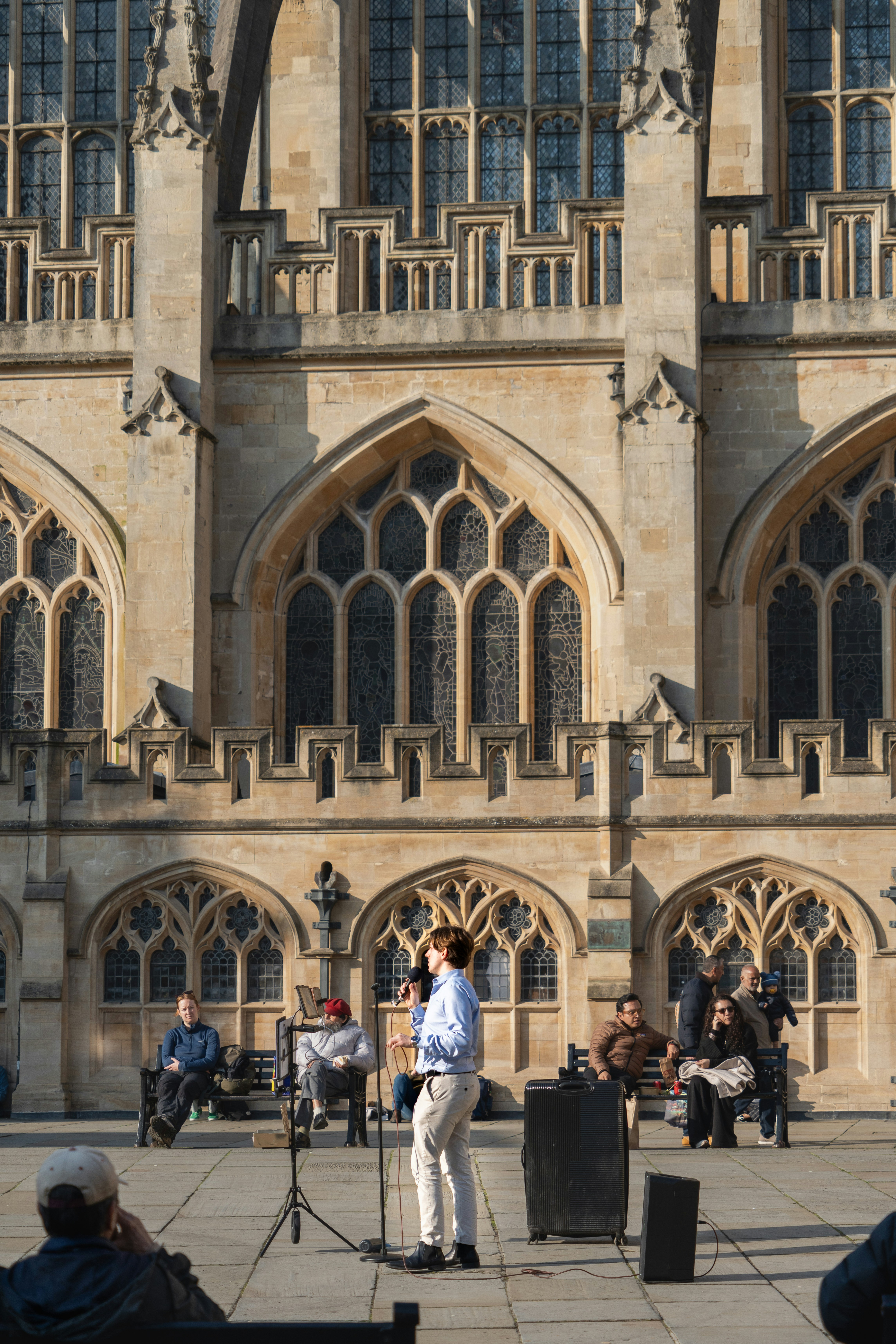 Speaker in a Historic Courtyard: A Street Concert Beneath Gothic Arches