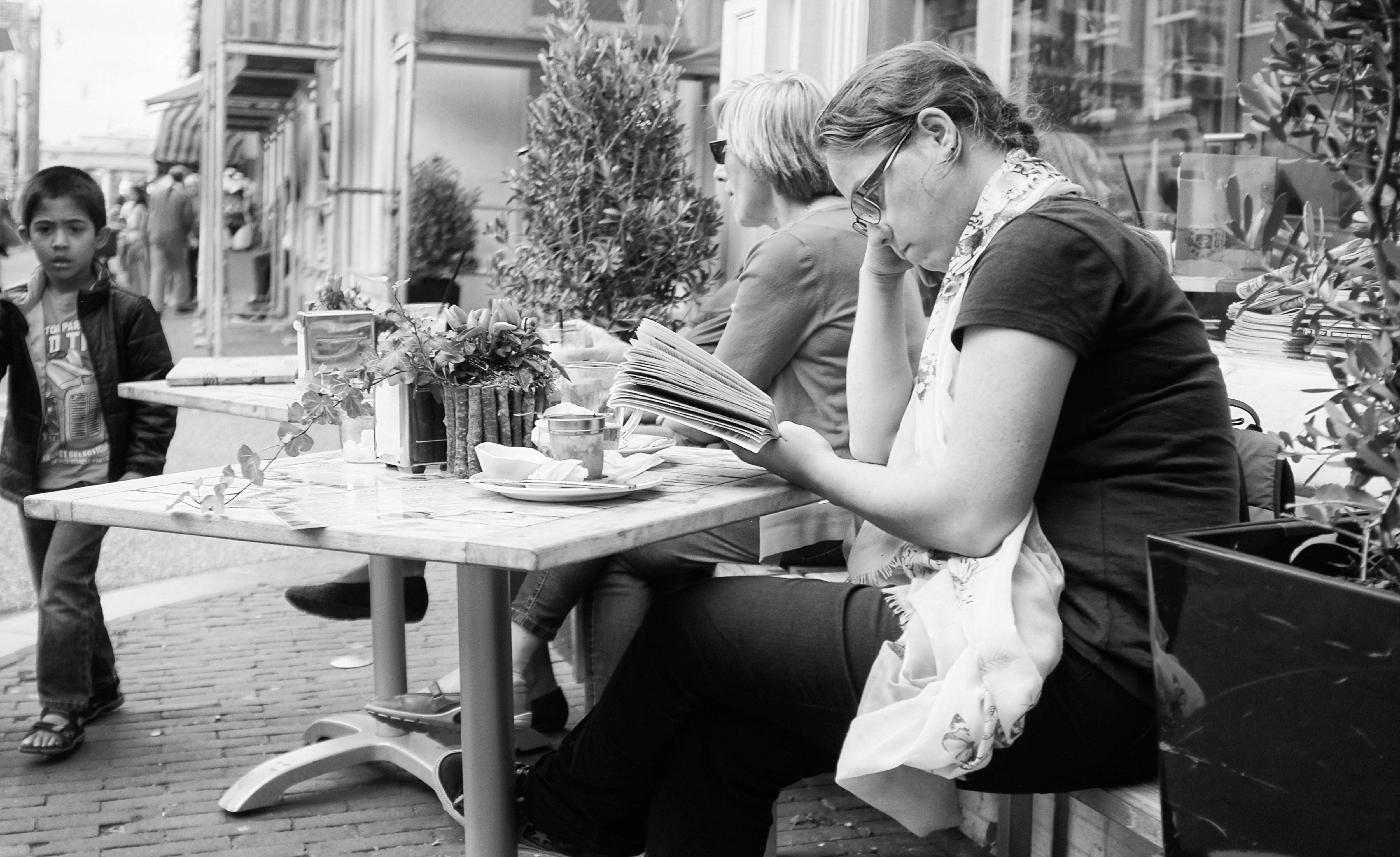 Reader in Focus: A Quiet Moment at the Outdoor Café
