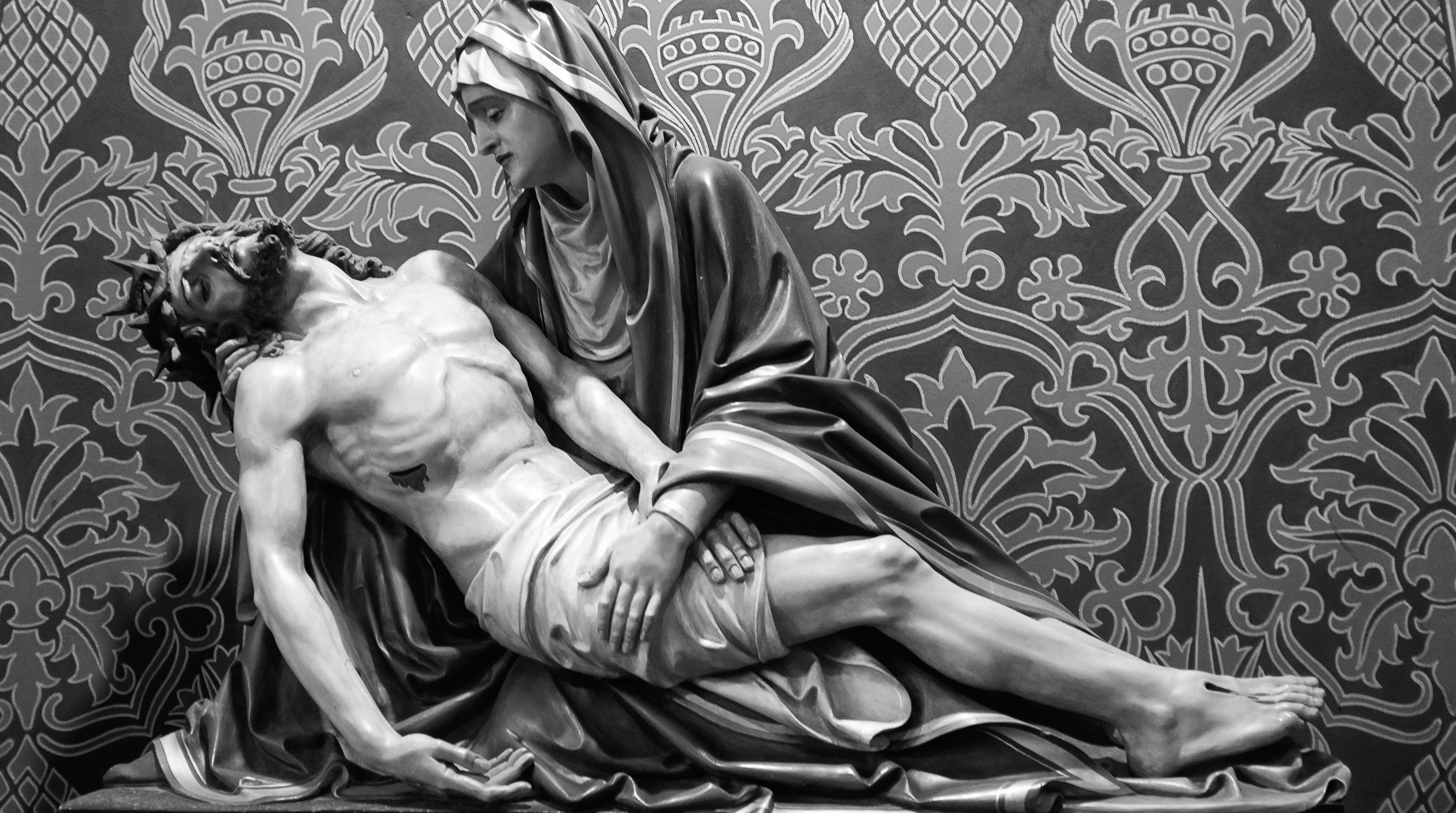 Stone Compassion: A Marian Relief Cradles a Wounded Figure