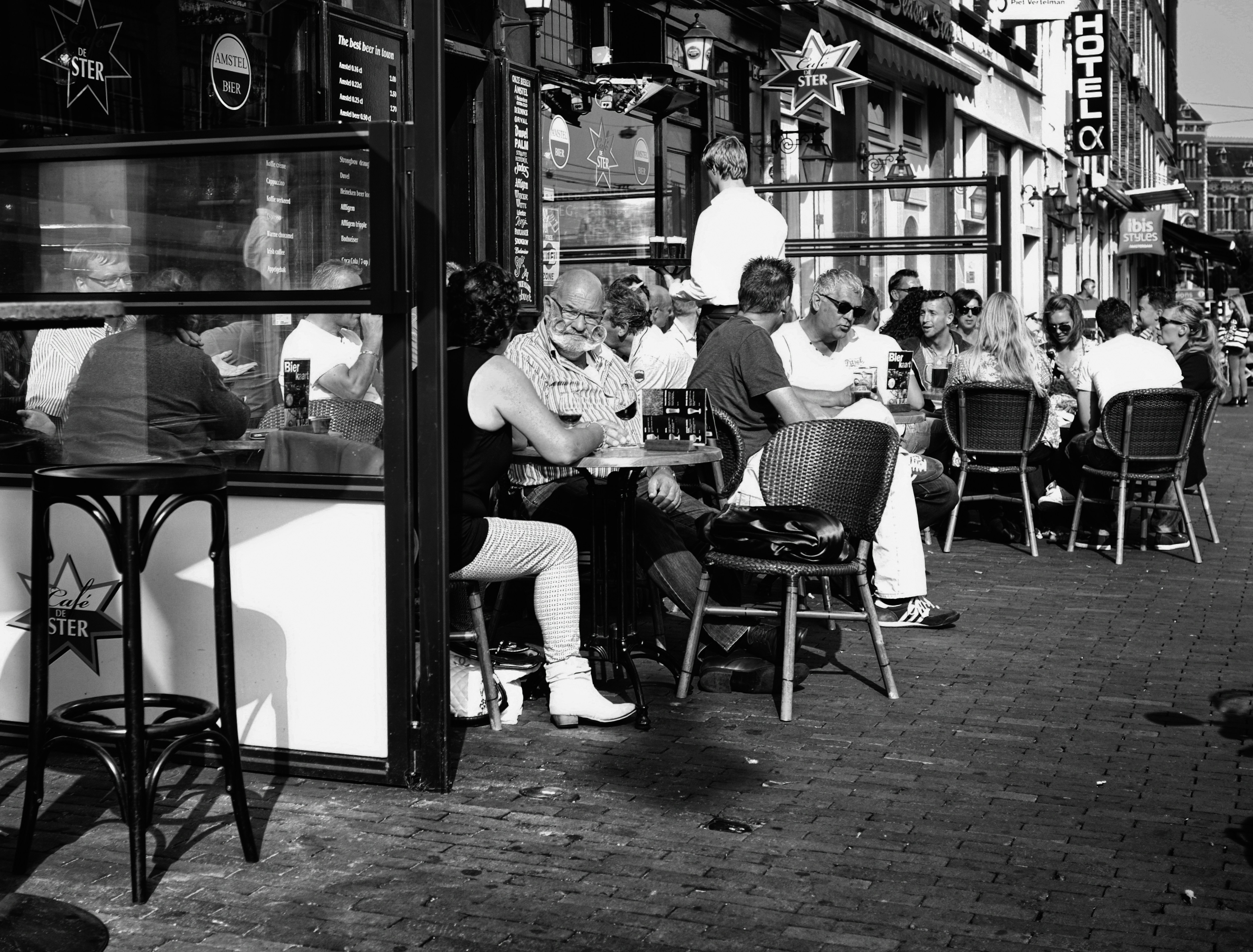 Café Street Mosaic: Faces and Quiet Conversations Under Neon Light