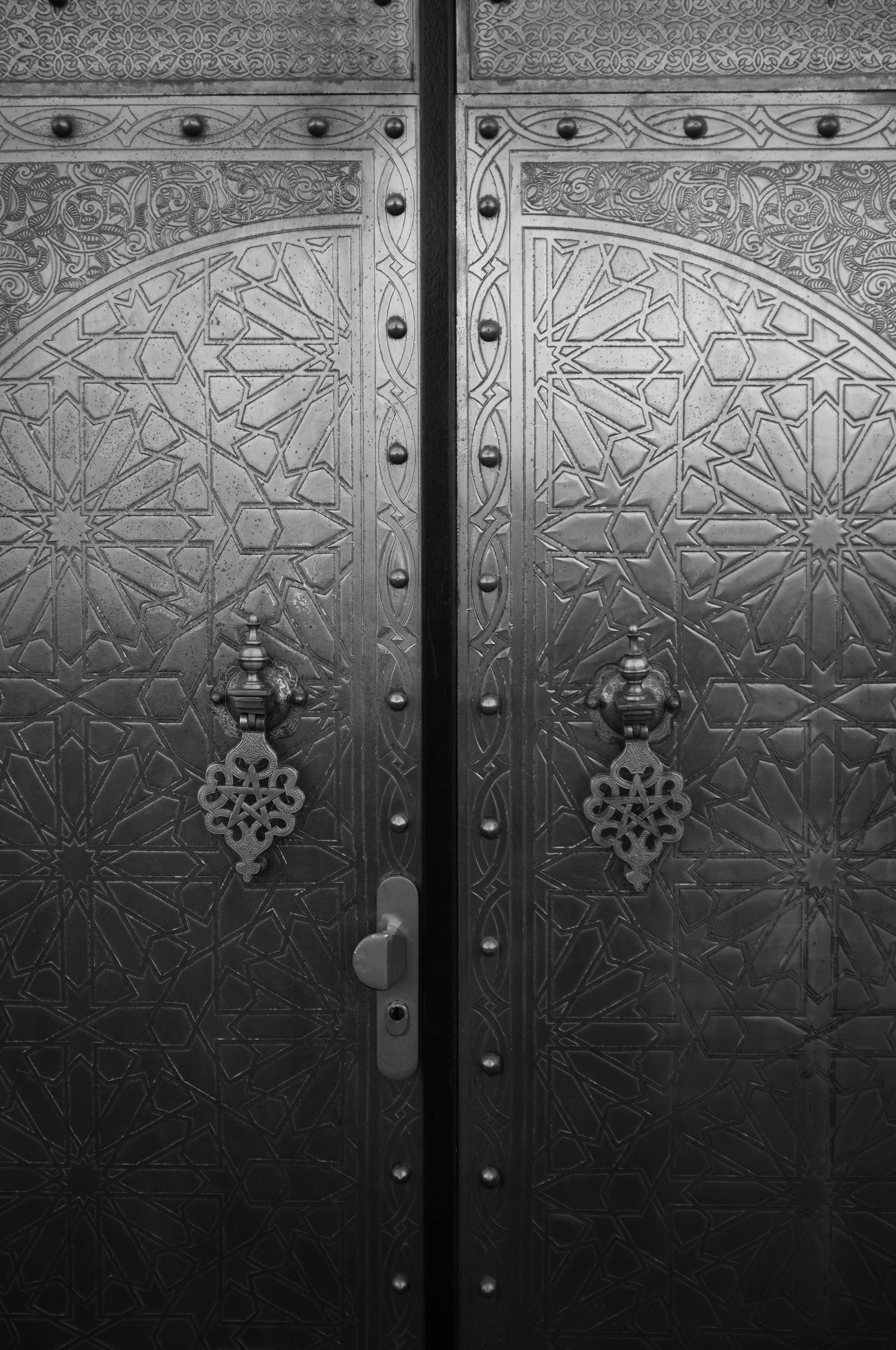 Ironwork Symmetry: A Closer Look at the Dual Carved Doors
