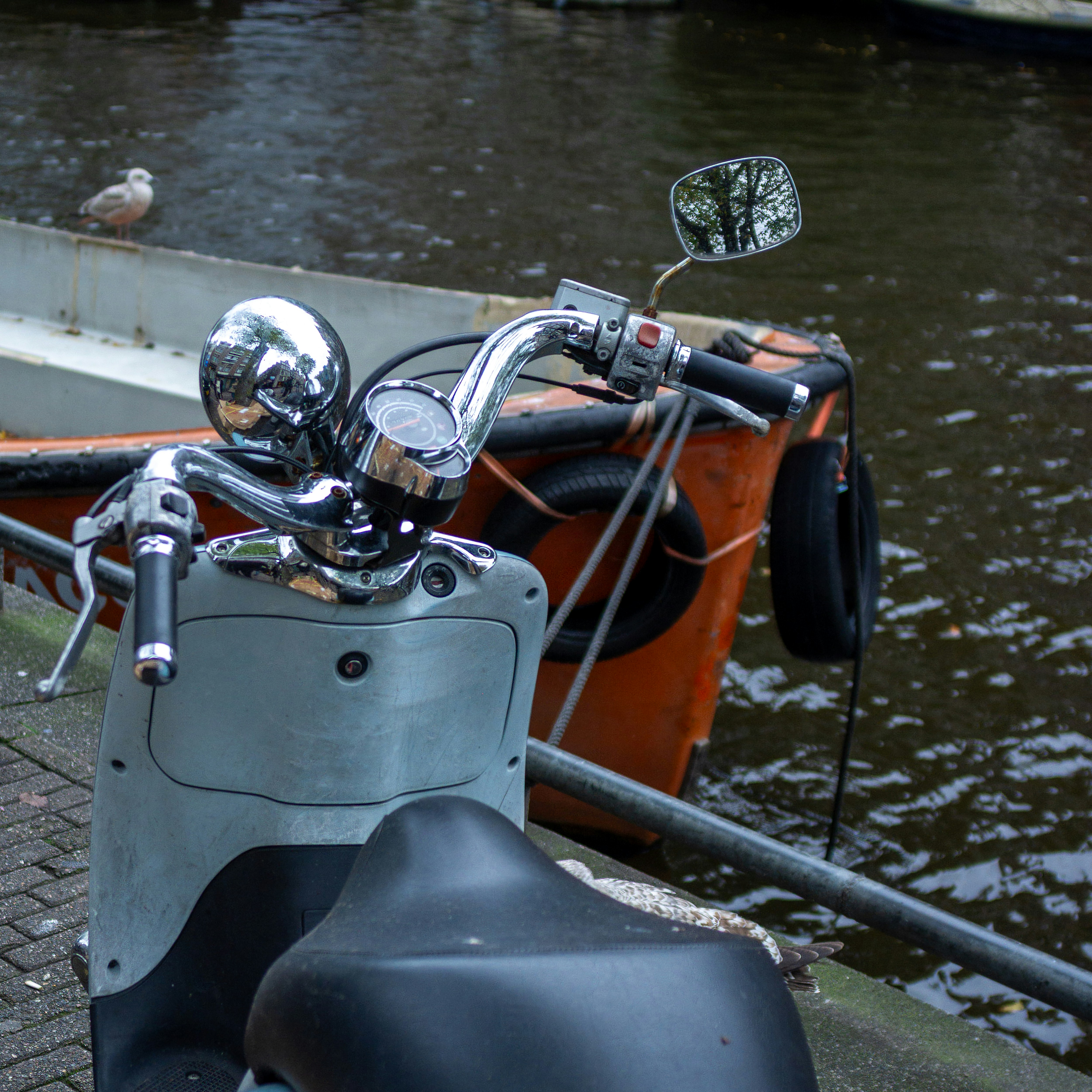 Vespar by the canal of Amsterdam
