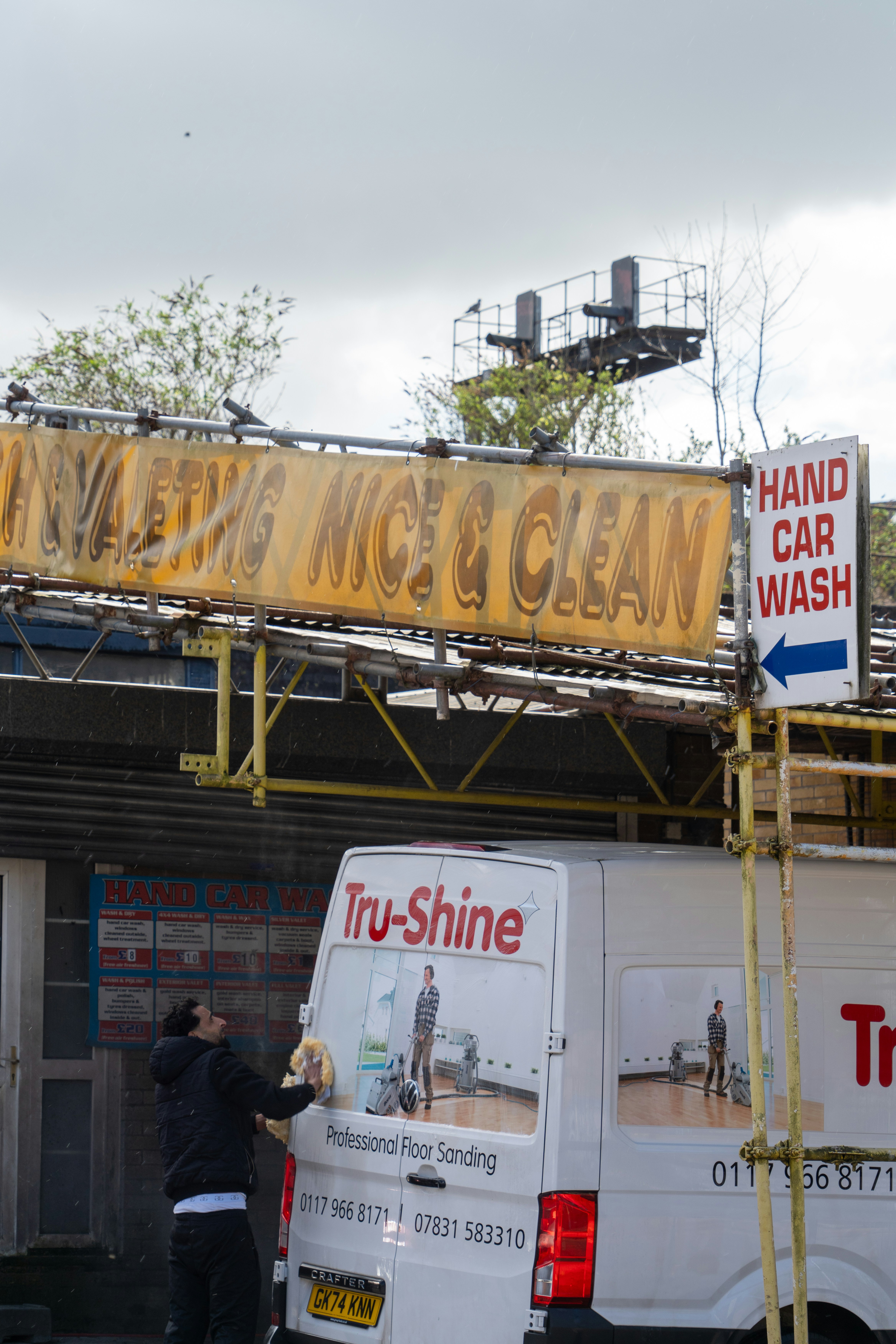 Rusted Signage and Service Van at a Weathered Car Wash