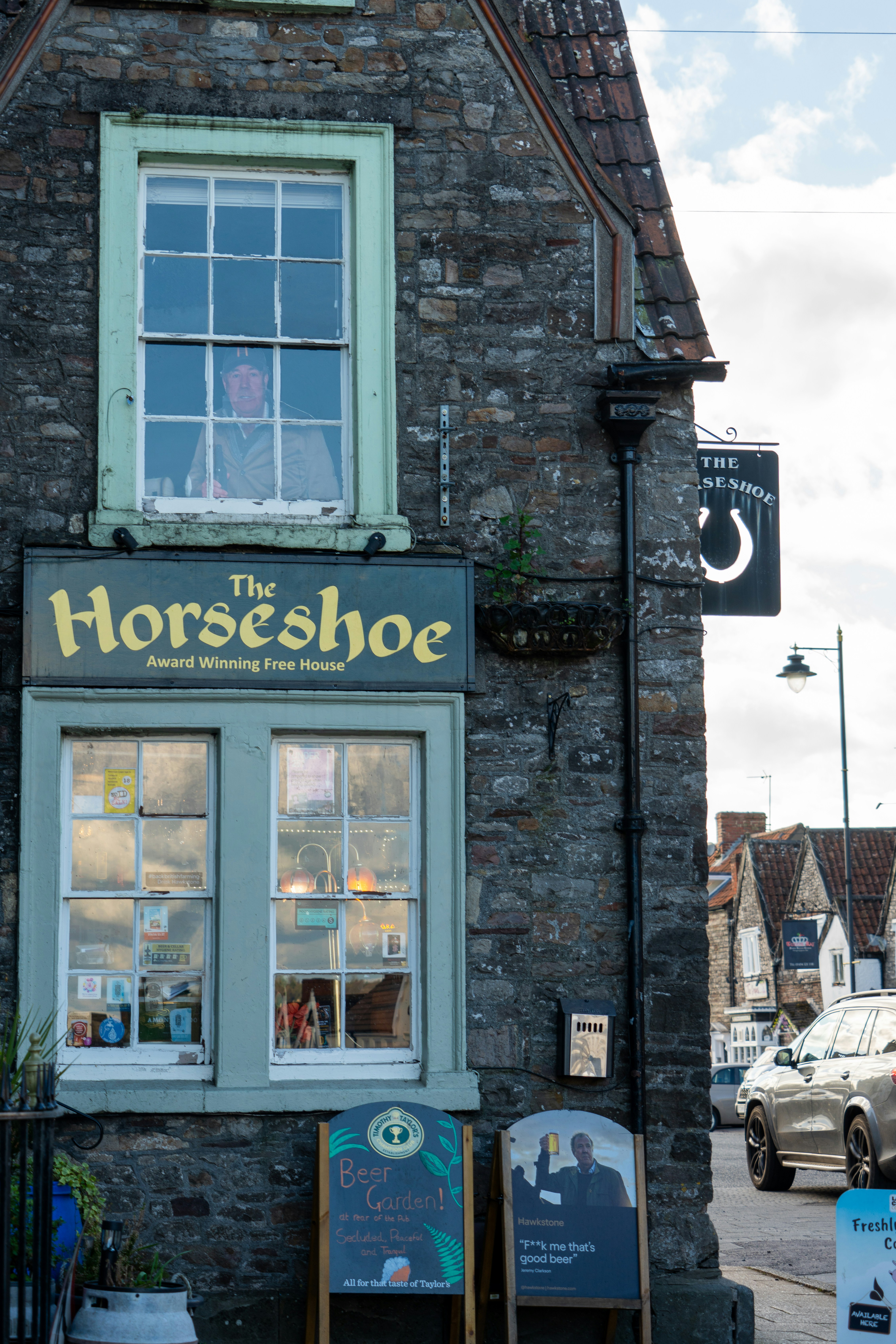 The Horseshoe: A Weathered Pub with a Watchful Window