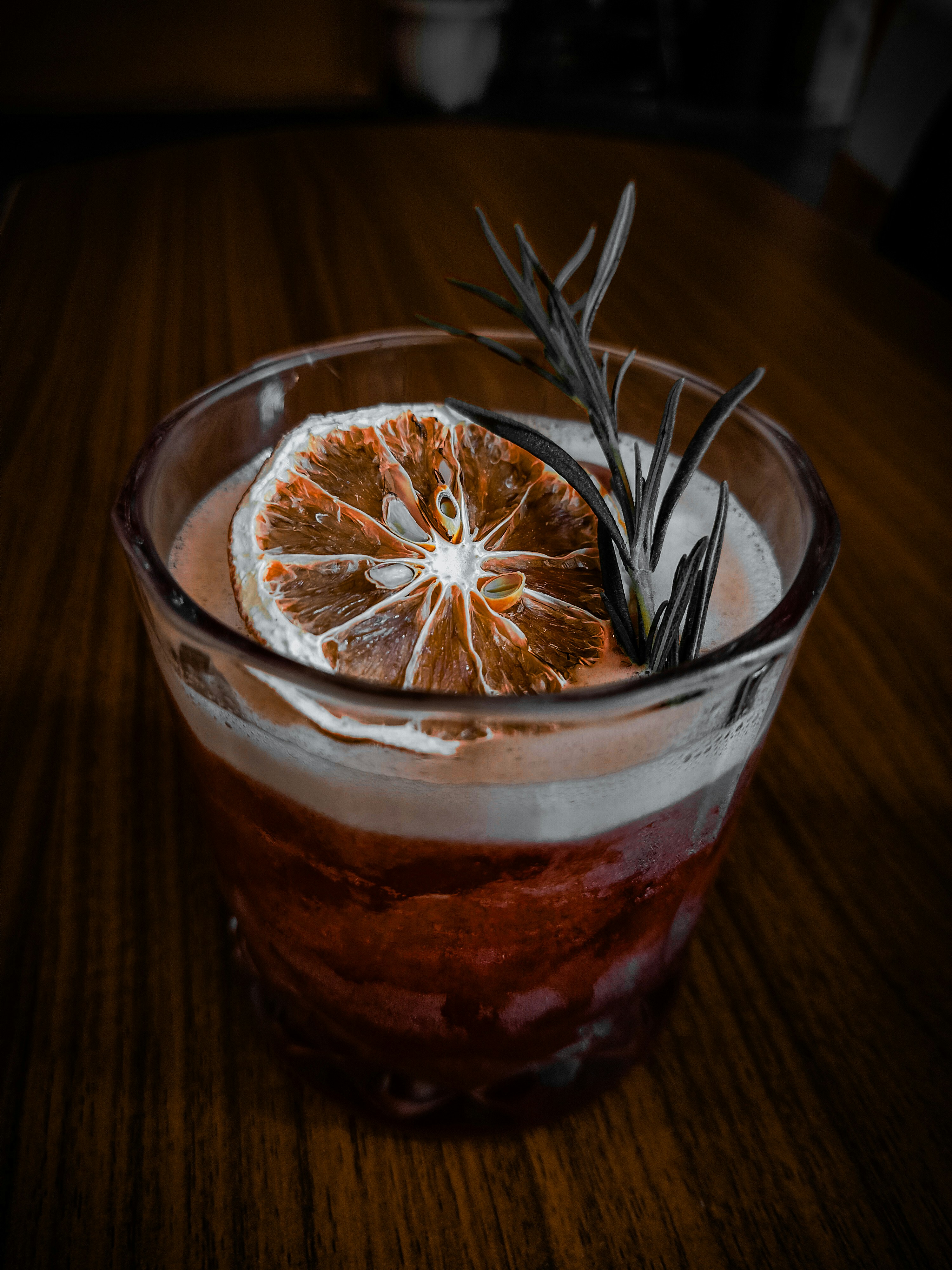 Citrus Spotlight: A Rosemary-Infused Cocktail on Woodgrain