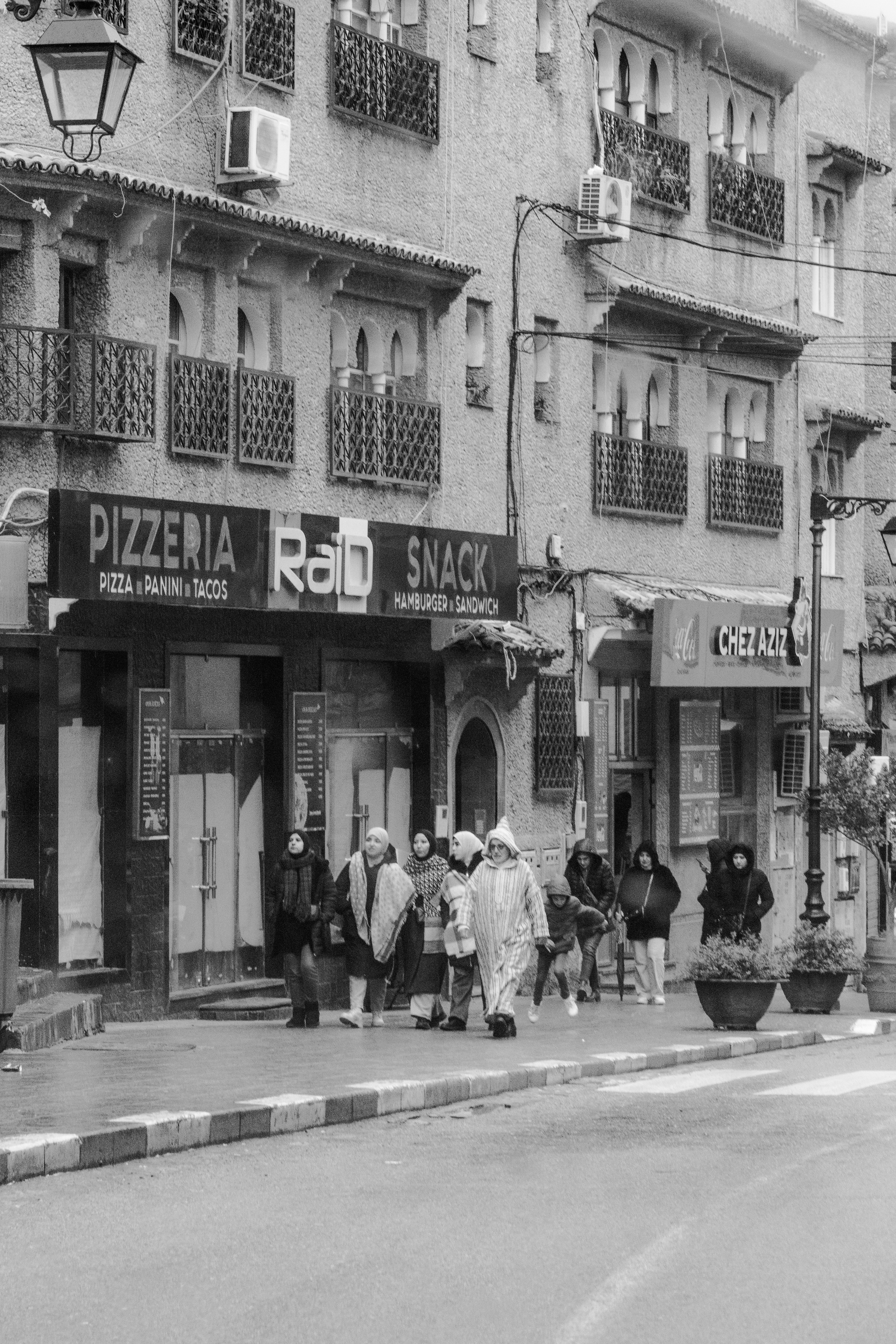 City Street Lanterns and Ramadan Crowd in a Monochrome Alley