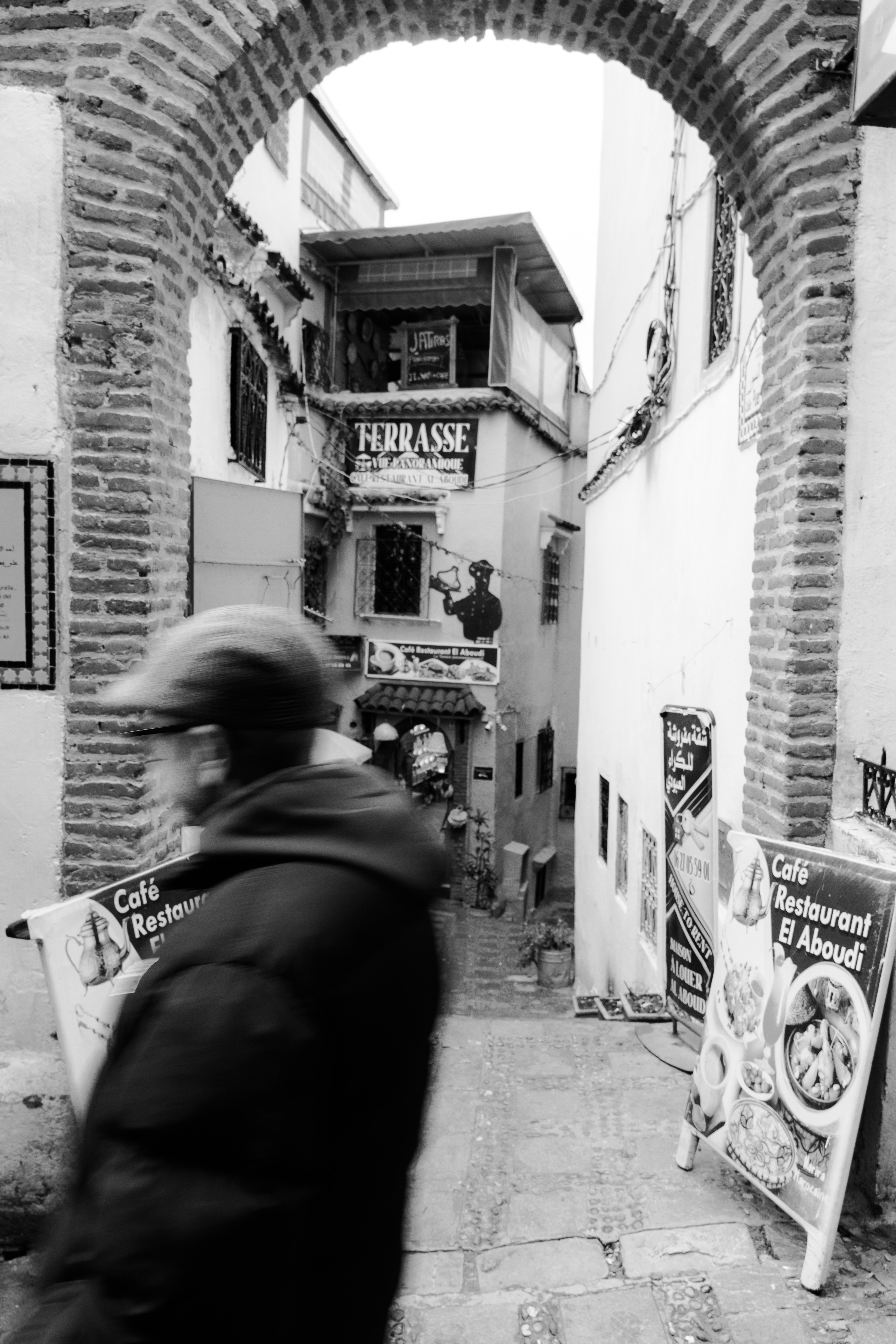 Archway to the Quiet Lane: A Narrow Street Framed by Aged Brick