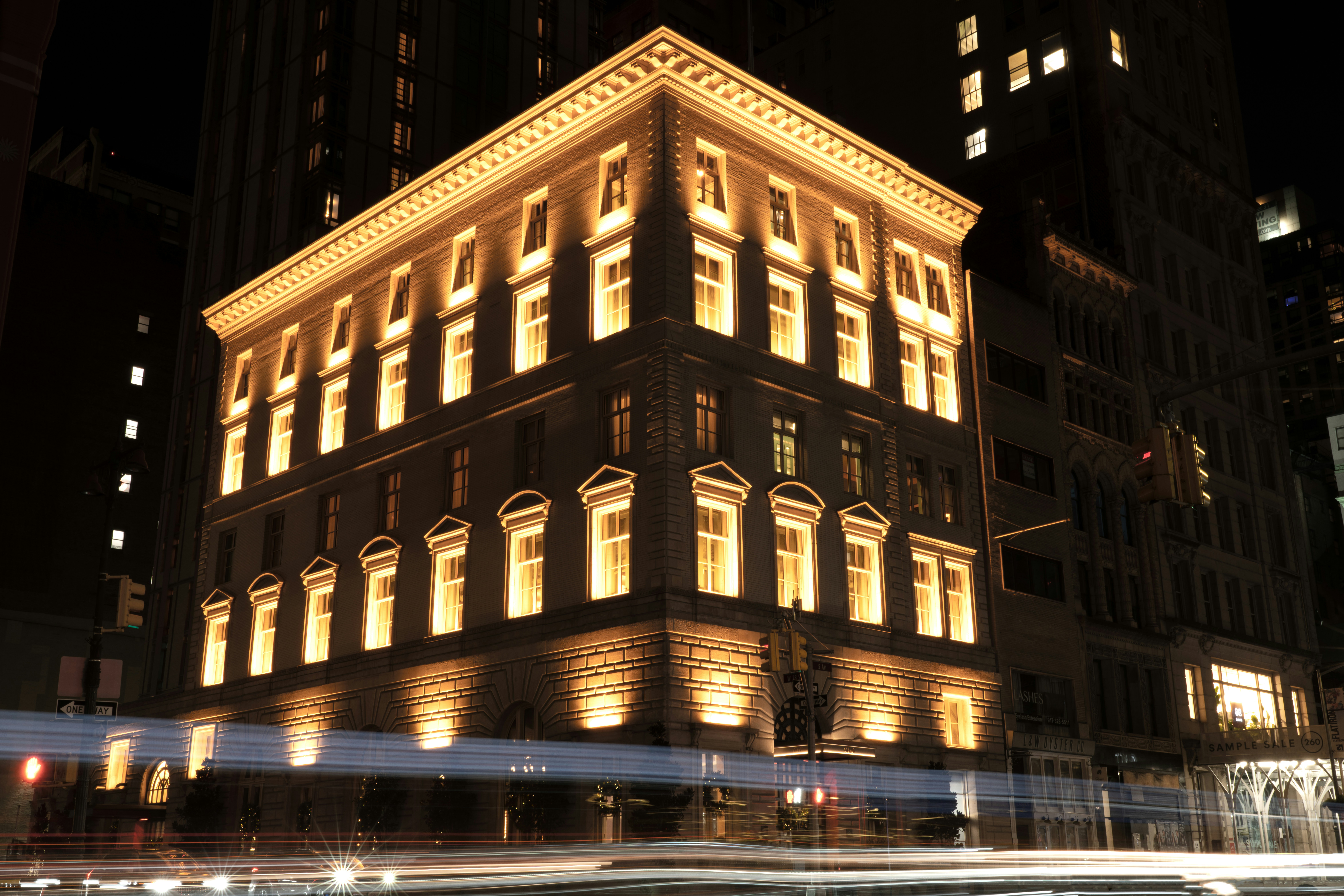 Nighttime Facade: A Well-Lit Neo-Gothic Corner in Motion