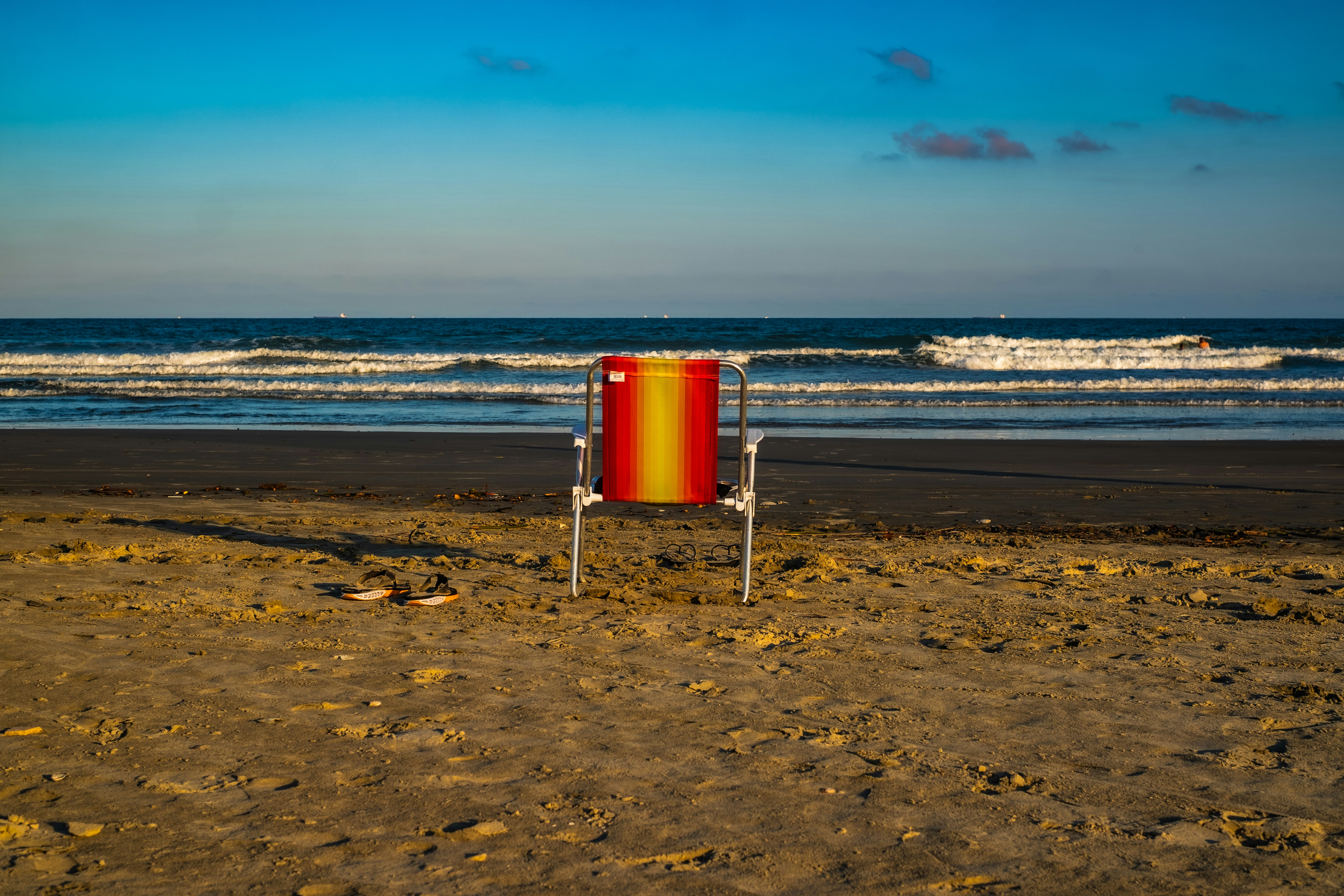 A Lifeline on the Beach: Red Barrel Framed by Dunes and Sea