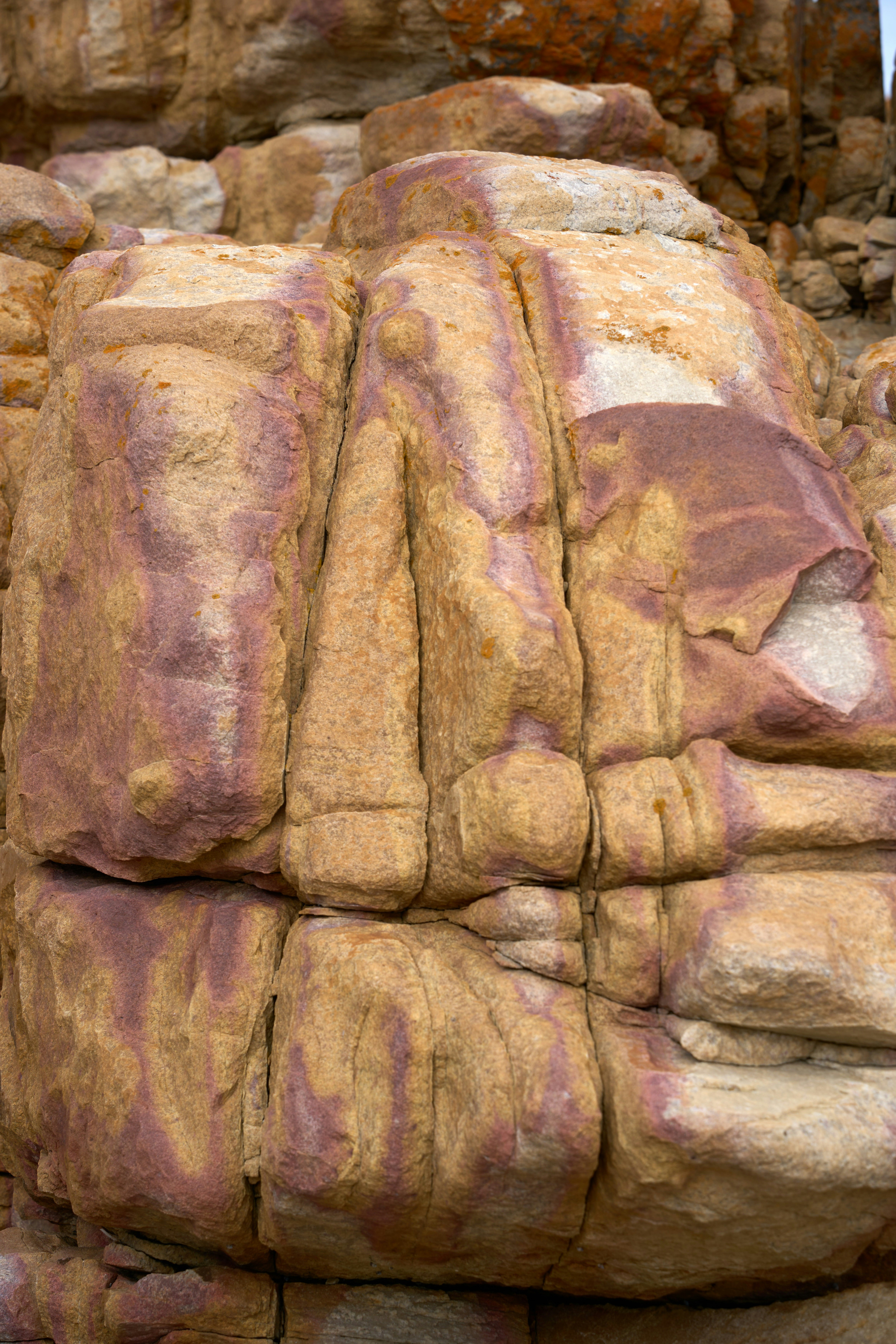 Striated sandstone sculpture: layered rock columns in warm desert tones