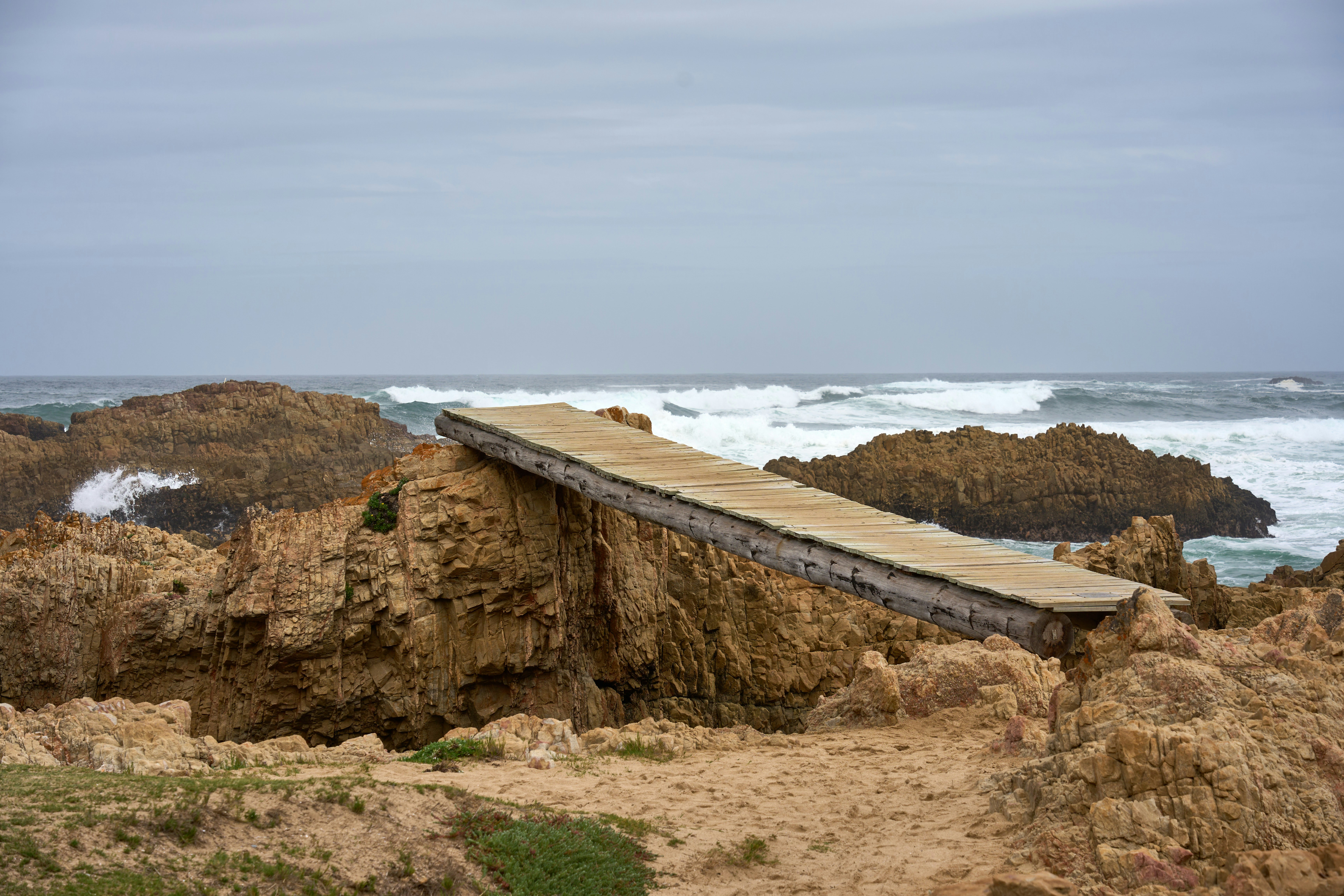 Bridge of Weathered Wood Over a Coastal Ledge