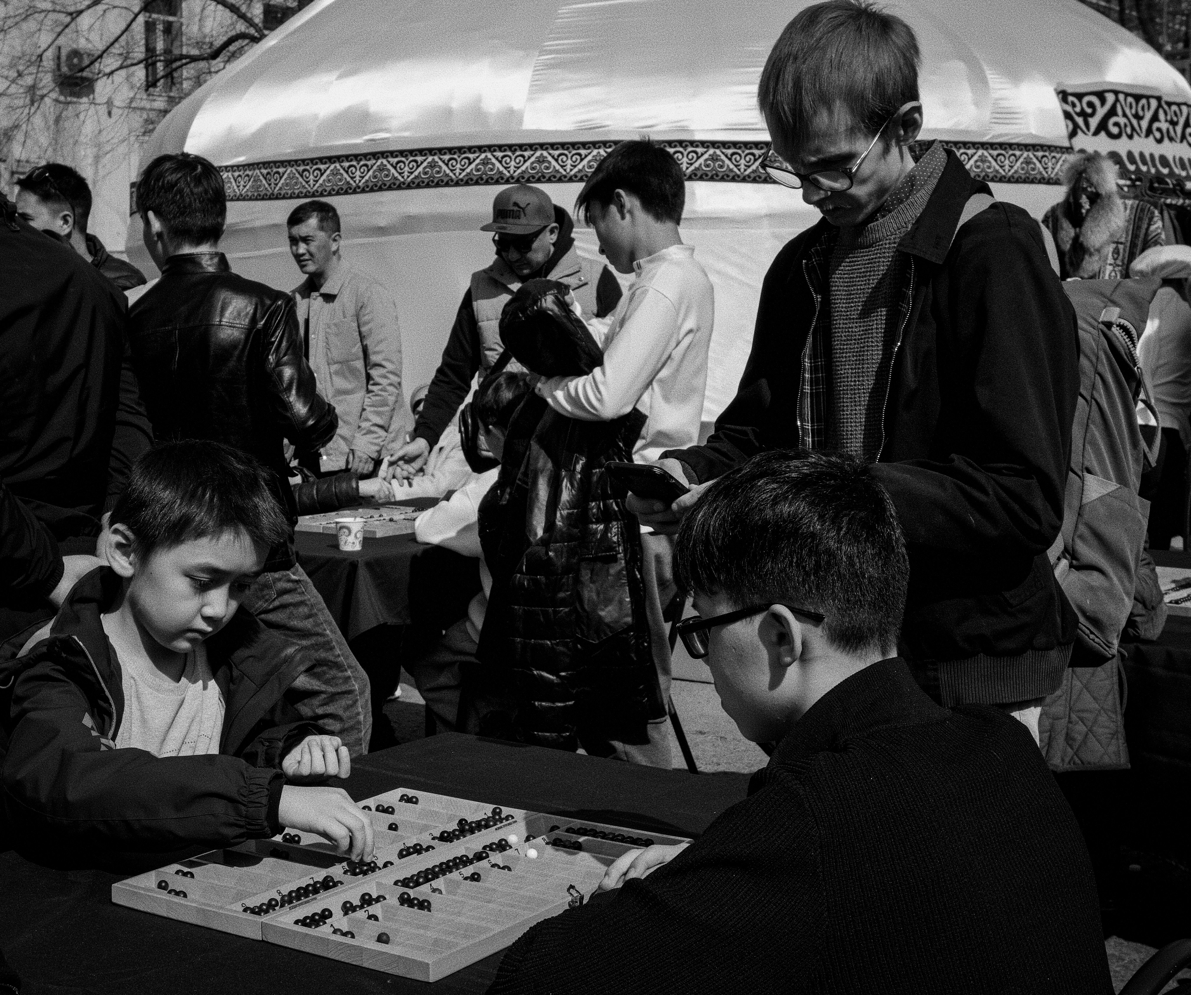 Strategic Moves at a Street Game Under the Tent
