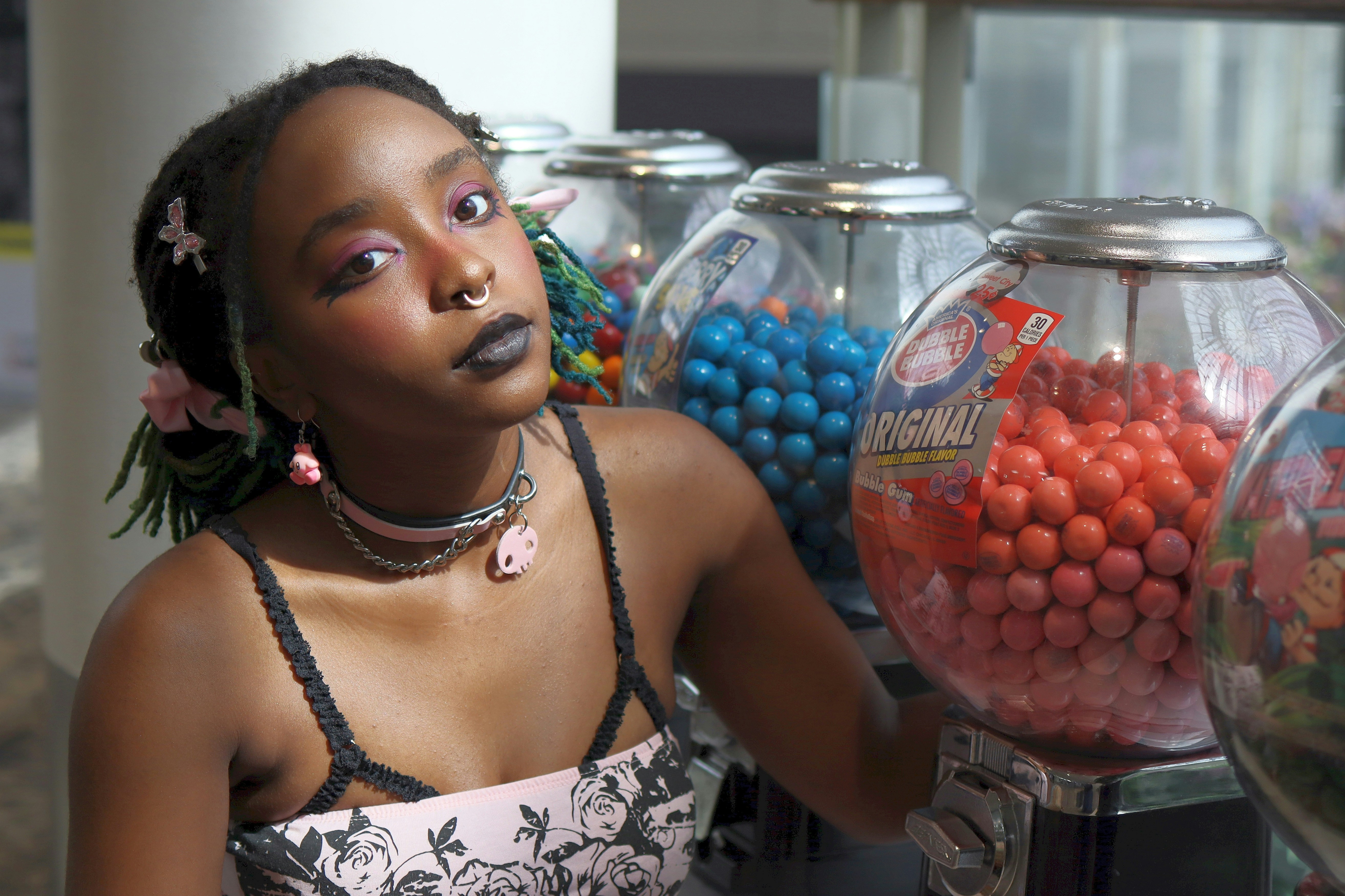 Sideglance in Candy Light: Portrait at a Gumball Stand