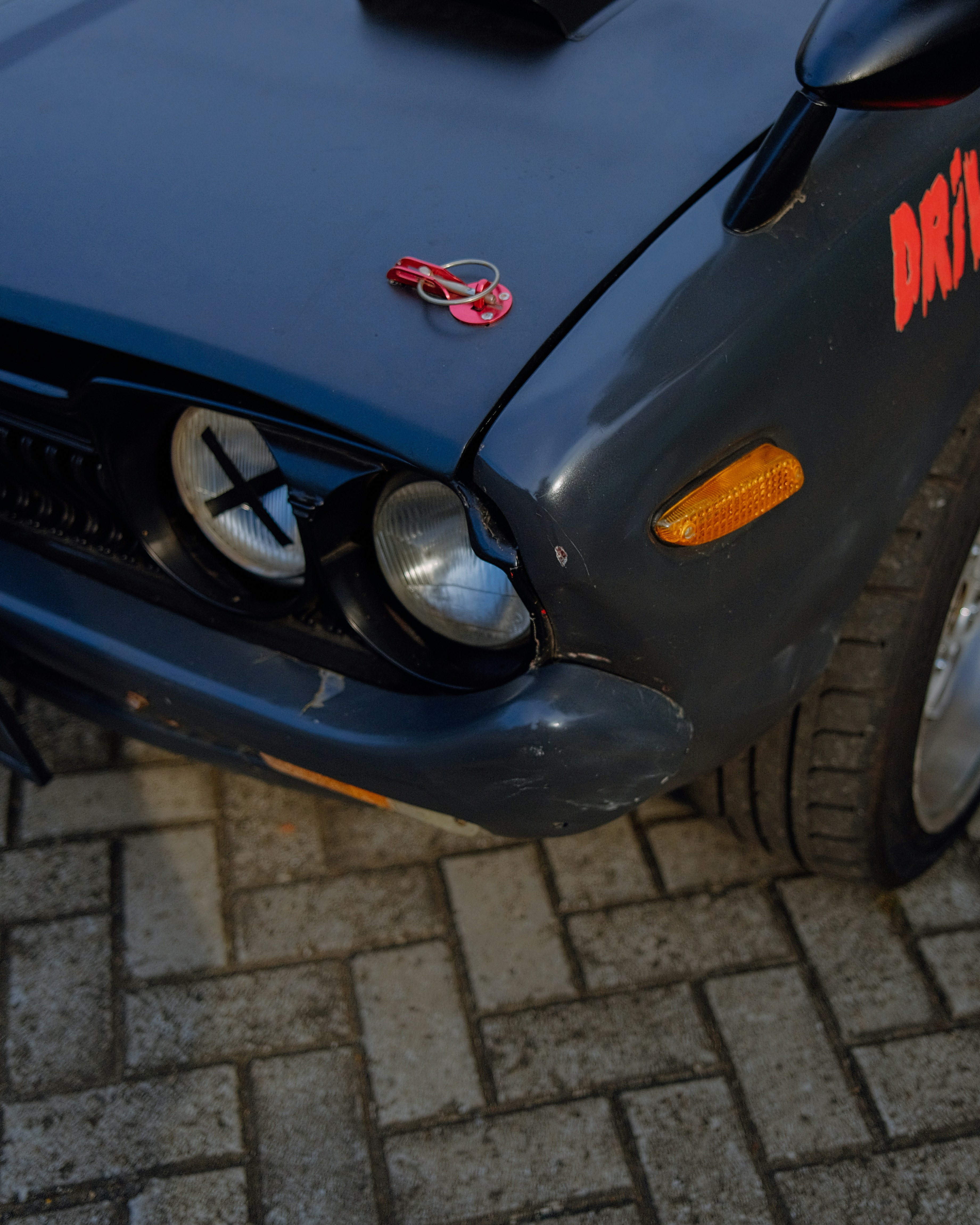 Worn Drifter: A Nostalgic Front-Quarter of a Classic with Red Emblem