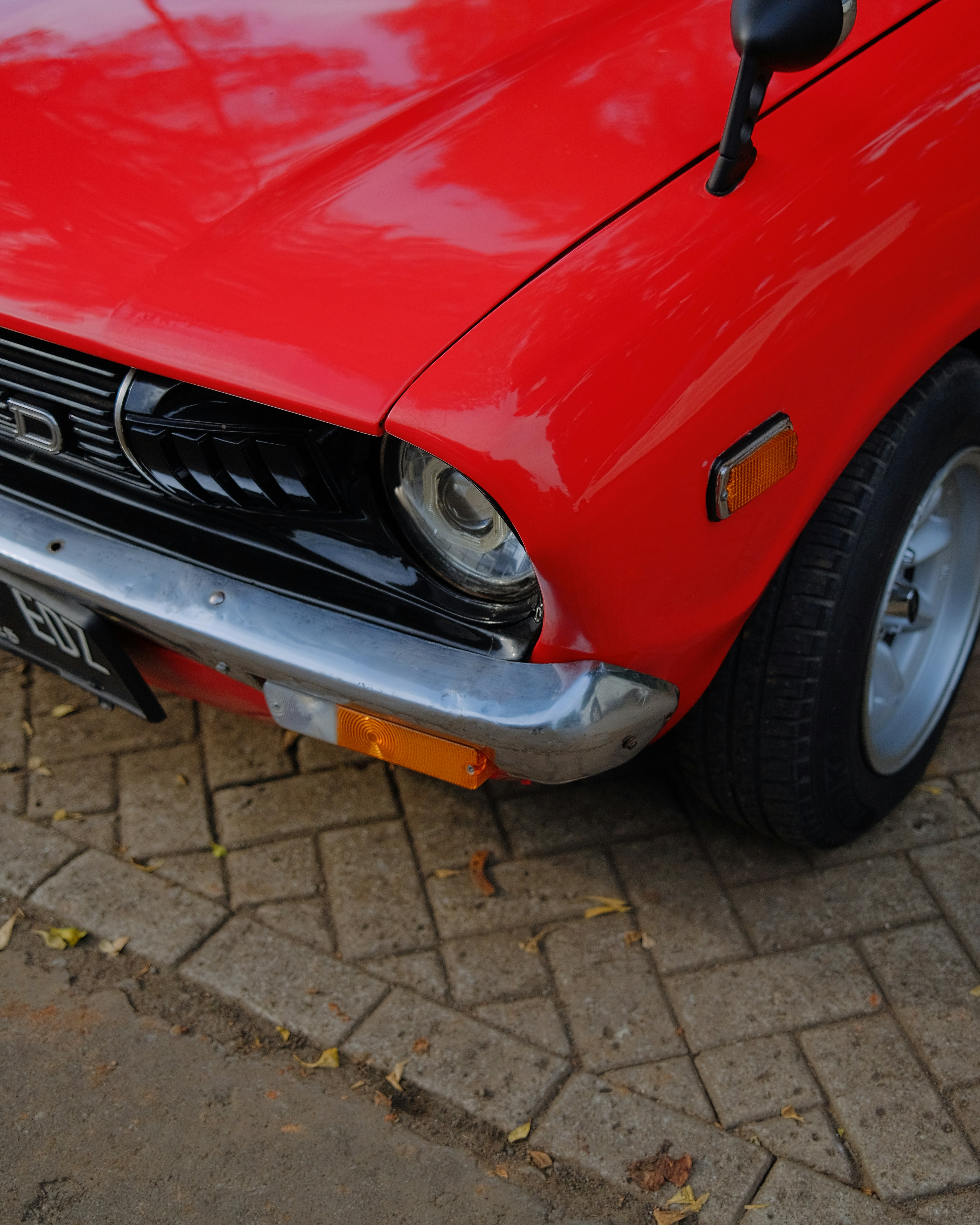 Red Echo: A Classic Car’s Front Quarter