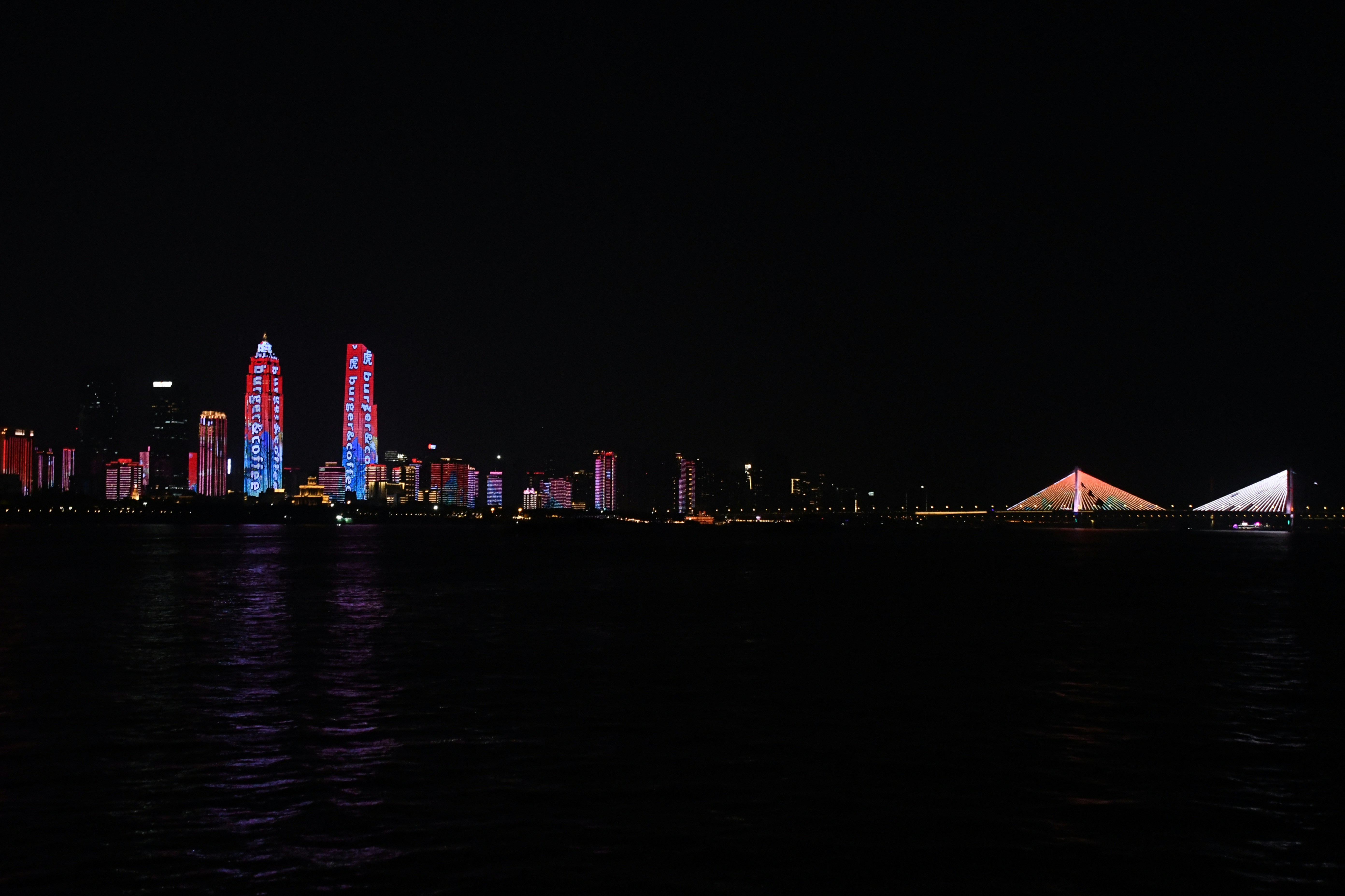 Neon Skyline Across Quiet Waters