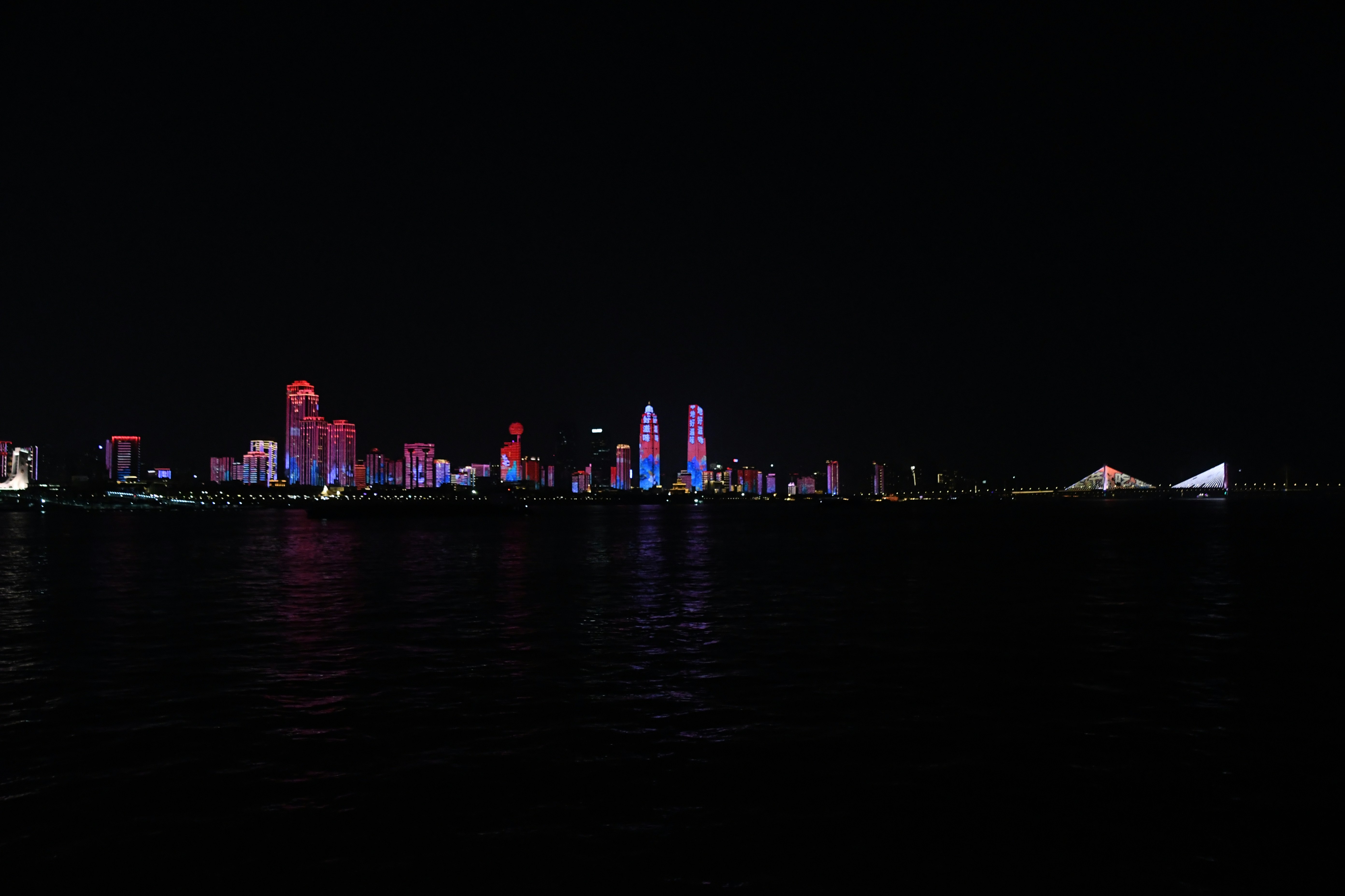 Midnight Skyline: Neon Reflections Across a Quiet Harbor