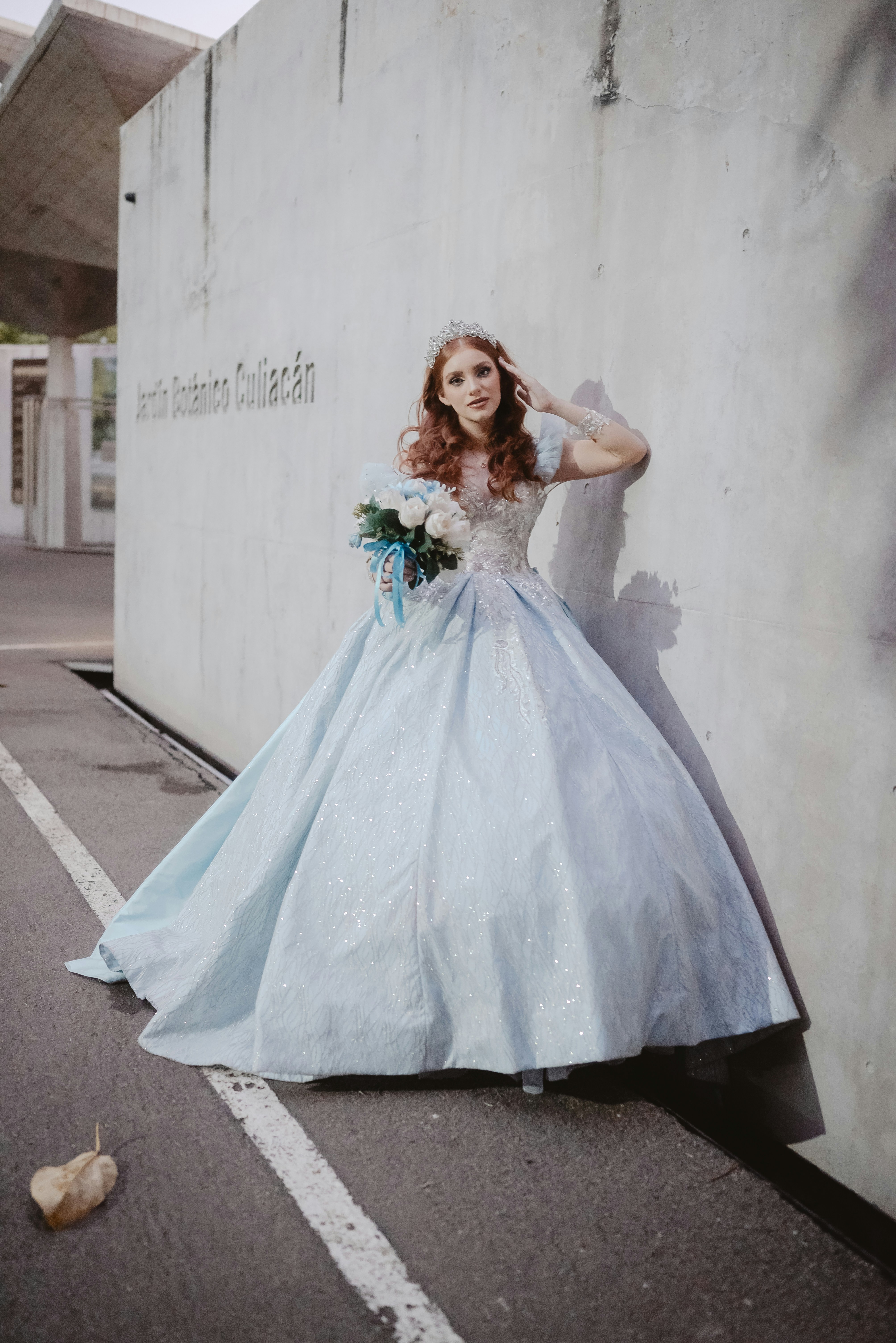Blue-tide Ballgown Against Concrete: A Bridal Moment by the Wall