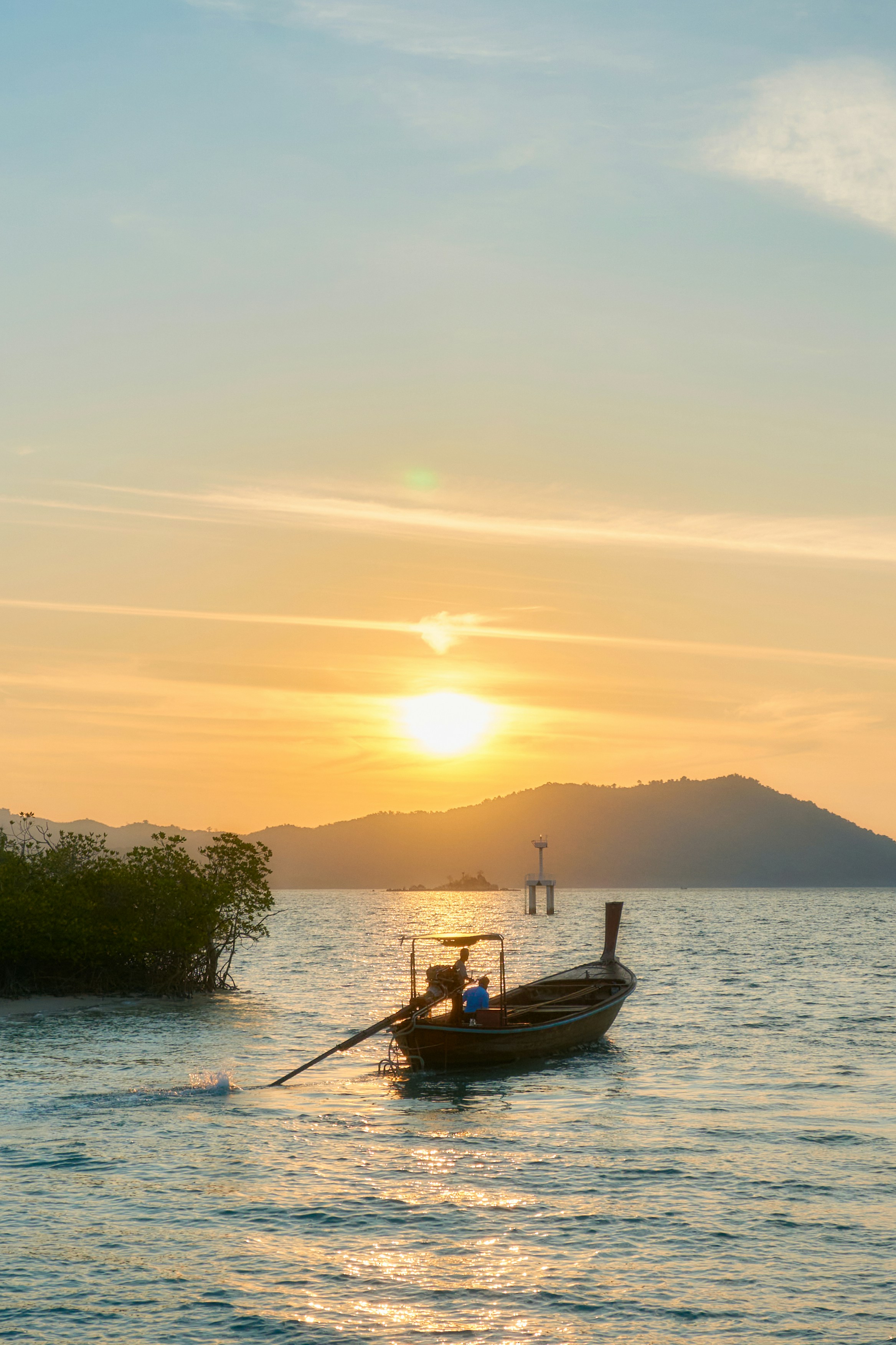 Sunlit Boat Drift Across a Golden Horizon