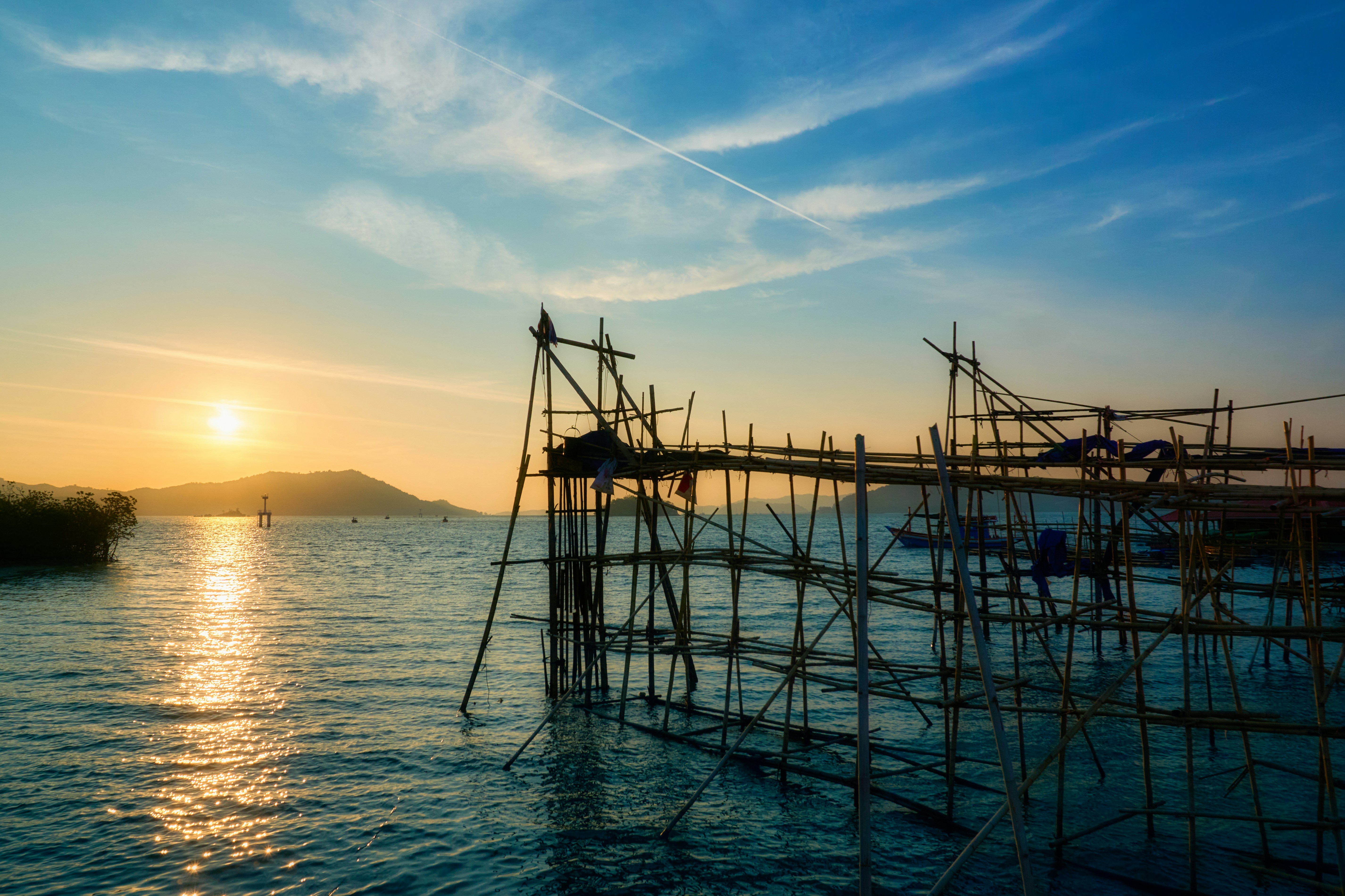 Sunlit Docks at Dusk: Wooden Skeins Reach into the Sea