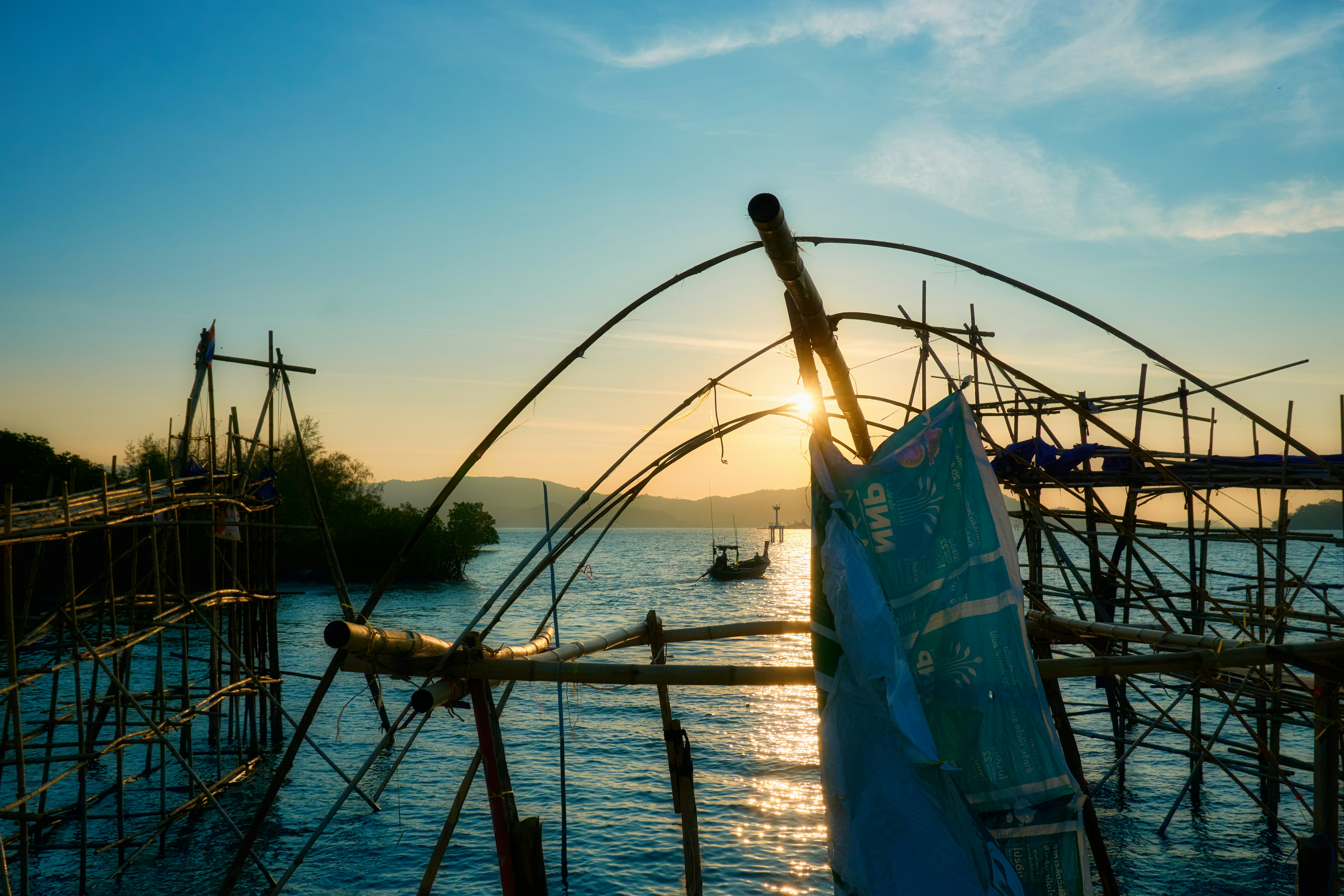 Sunlit Frames: Bamboo Structure Framing a Calm Delta at Dusk