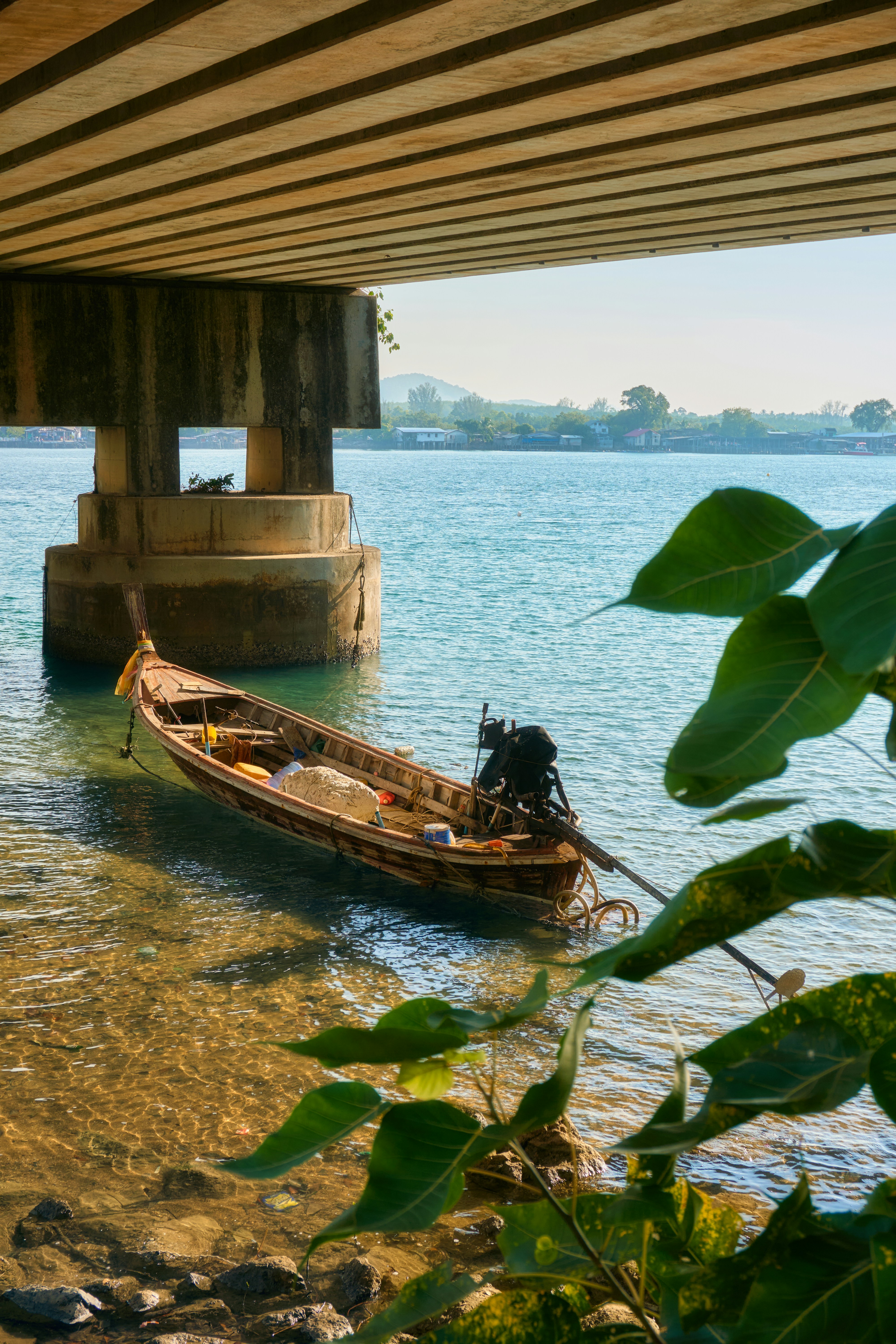 Under the Bridge, a Lone Boat Resting on Quiet Tides