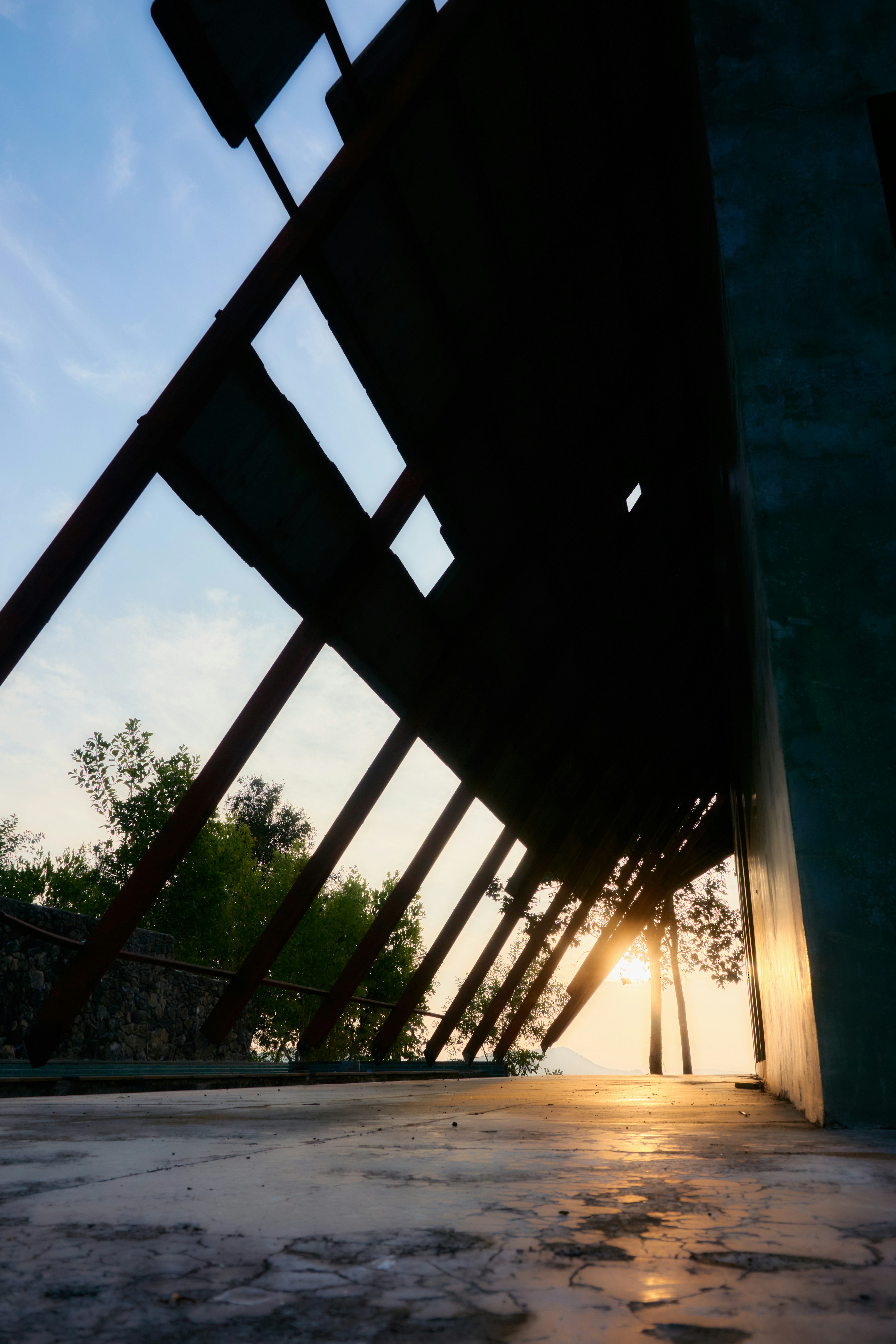 Sunlit staircase under angular beams: a doorway to the fading day