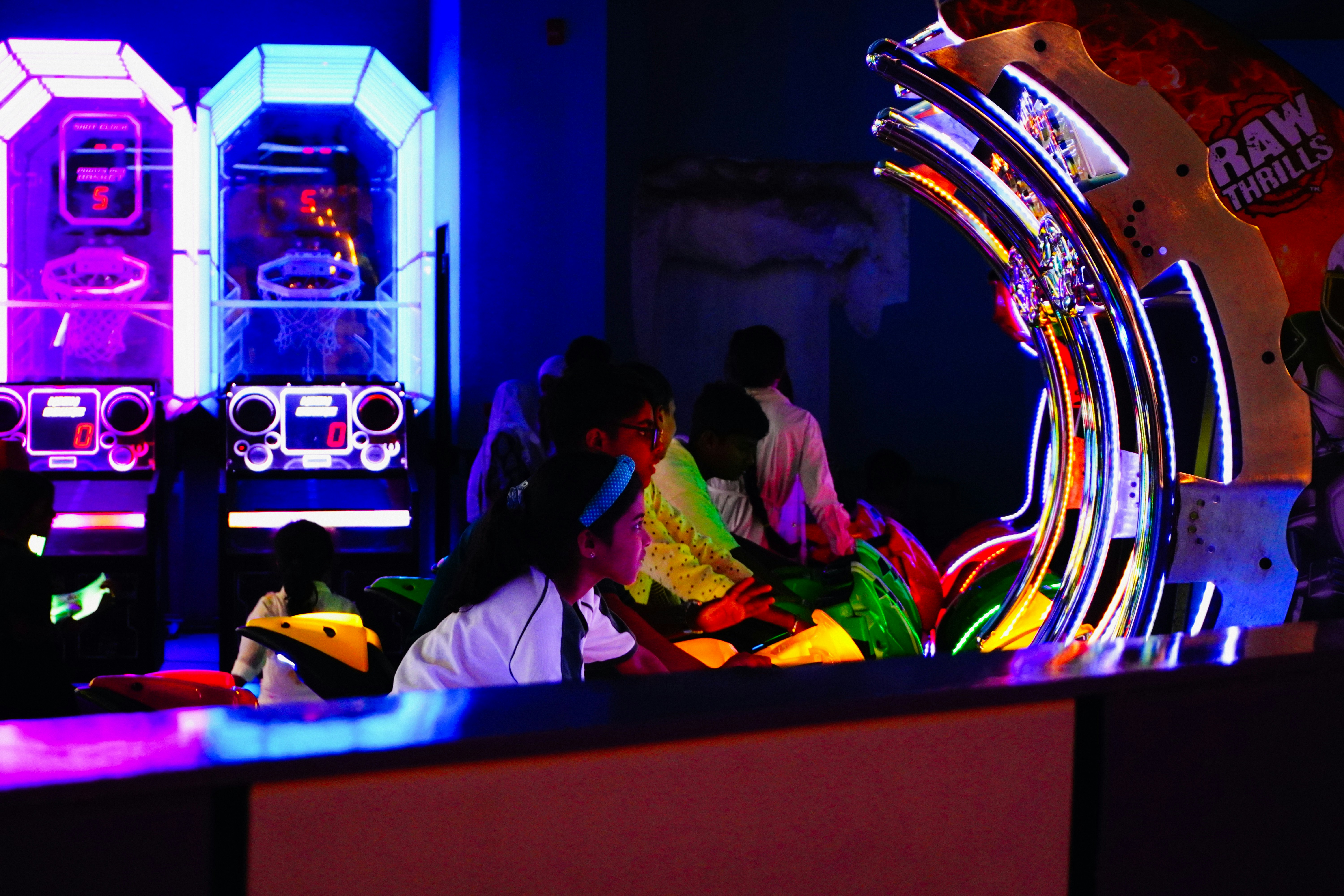 Neon Arcade in Motion: Riders and Lights in a Nighttime Carousel