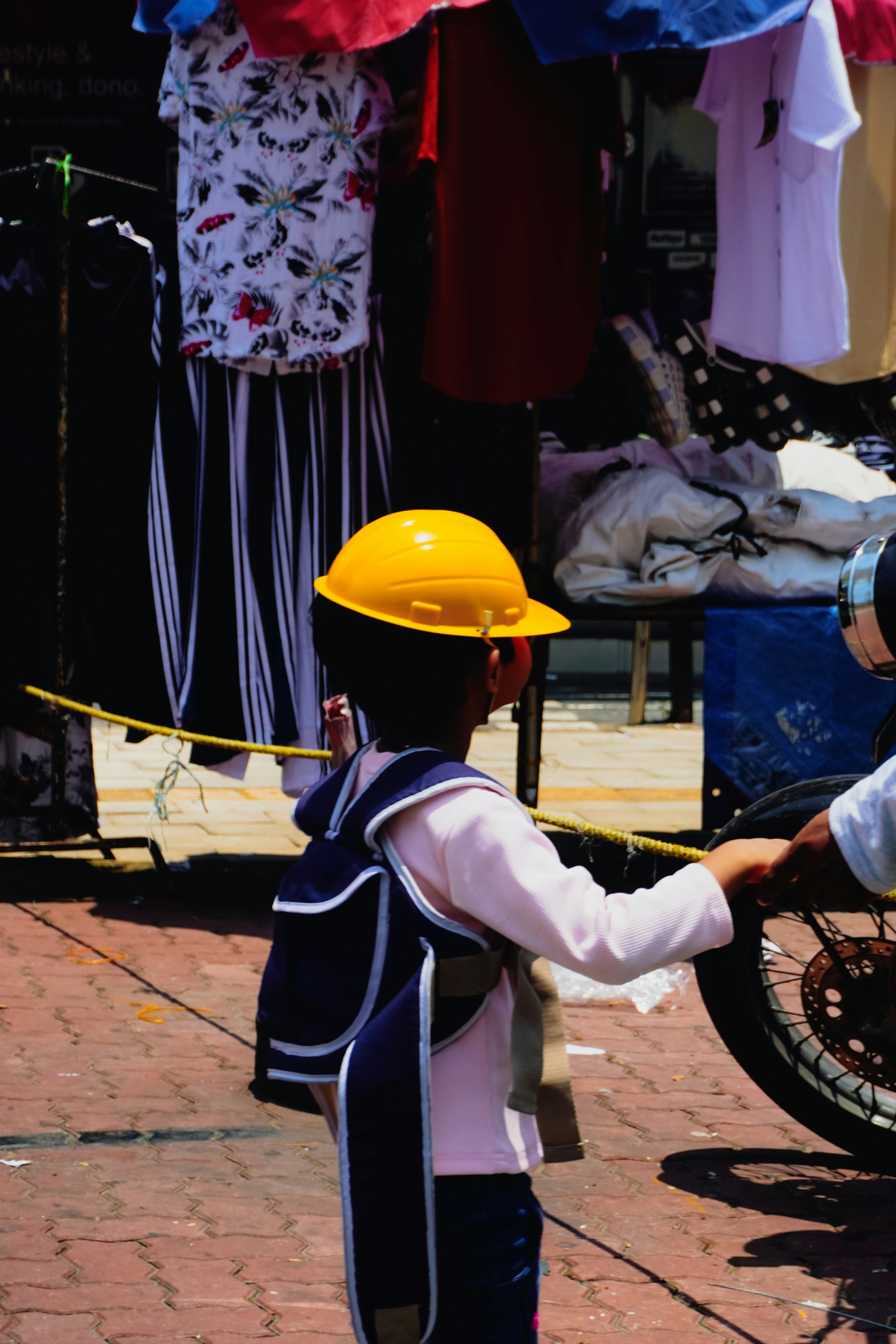 Yellow Hard Hat at the Market: A Child in Focus
