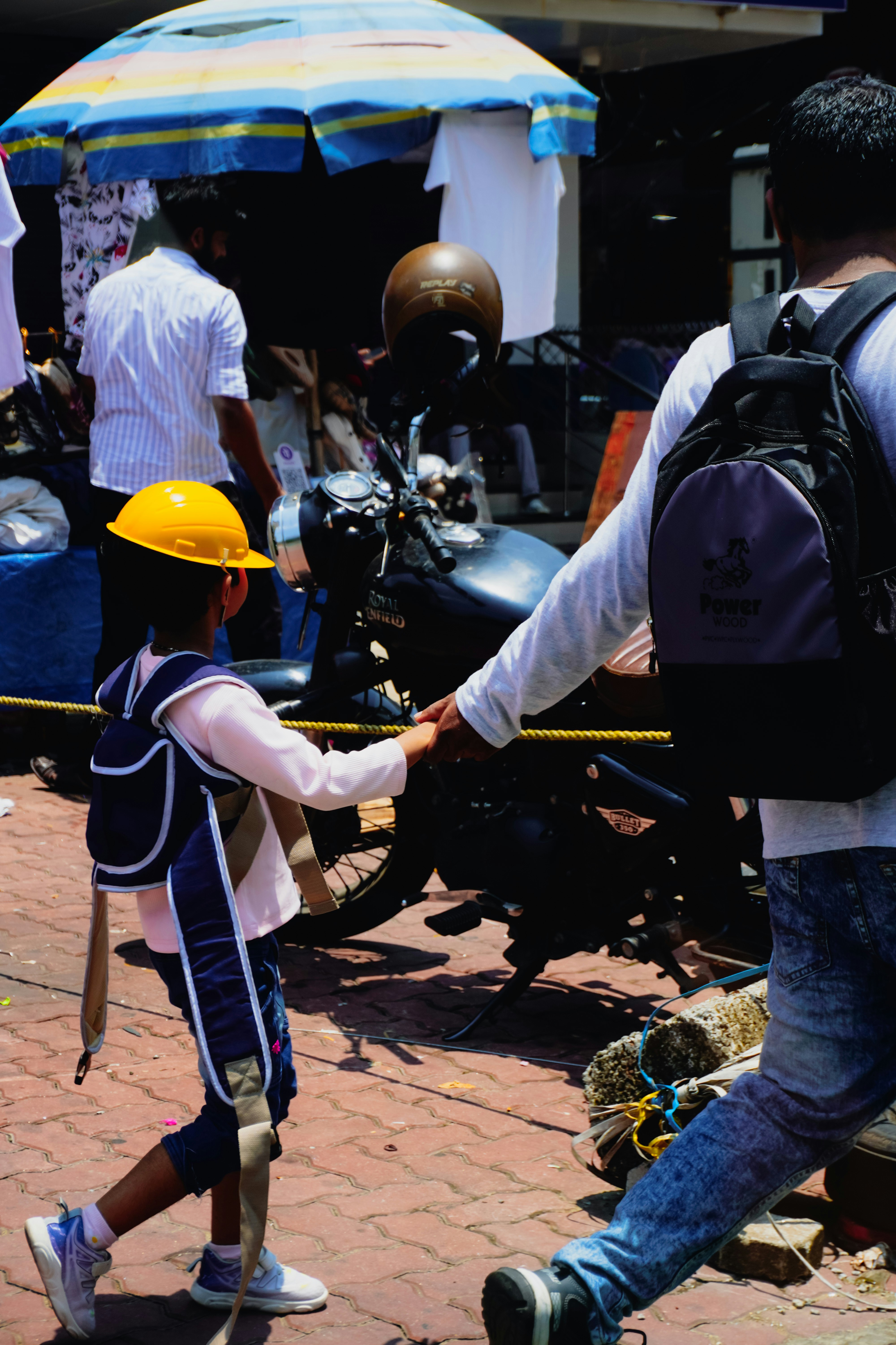 Handshake at the Market: A Young Helper and a Cyclist Share a Moment