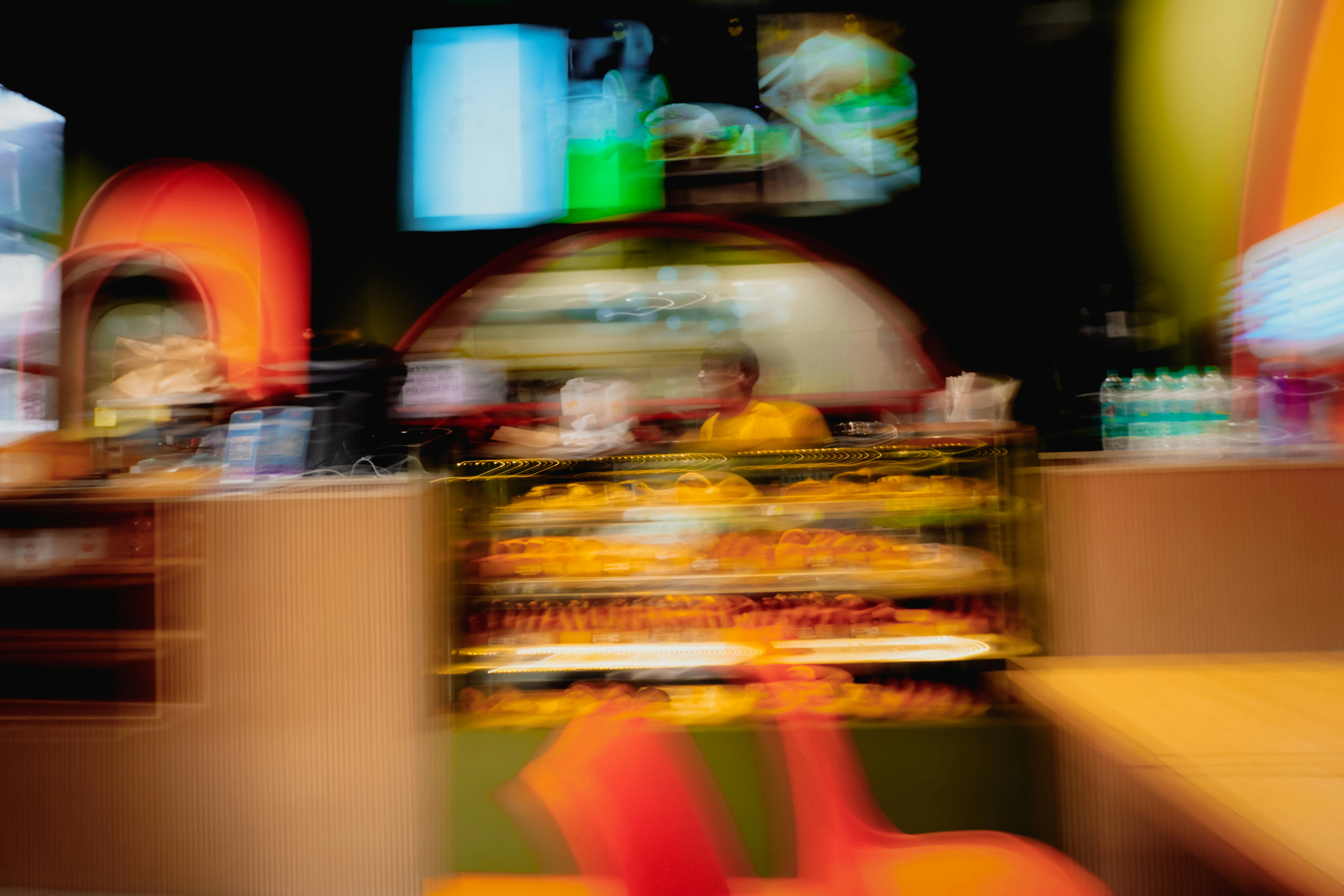 Vibrant Blur: A Colorful Café Scene in Motion