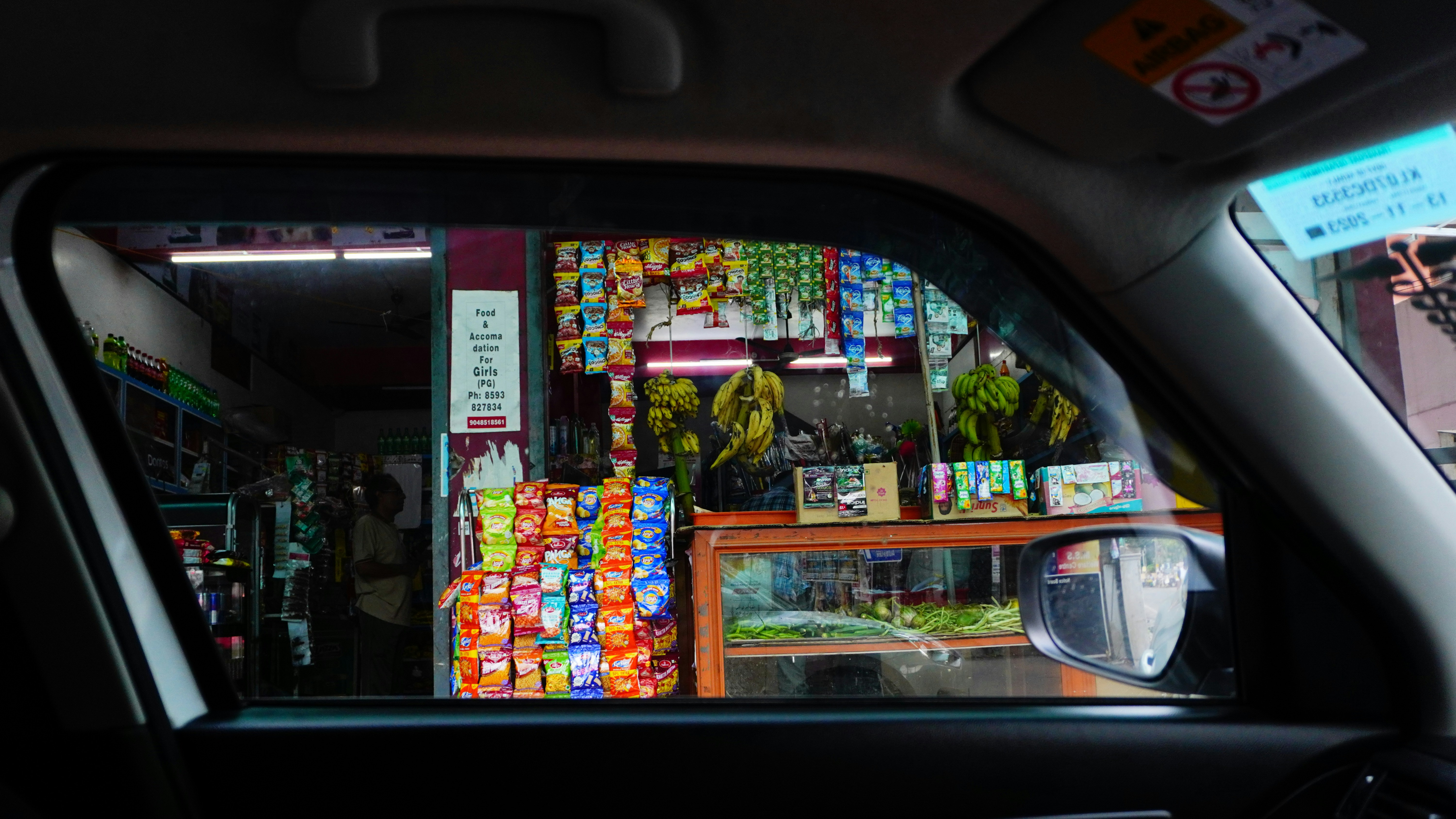 Through the Driver’s Window: A Market Scene Framed by Car Interior