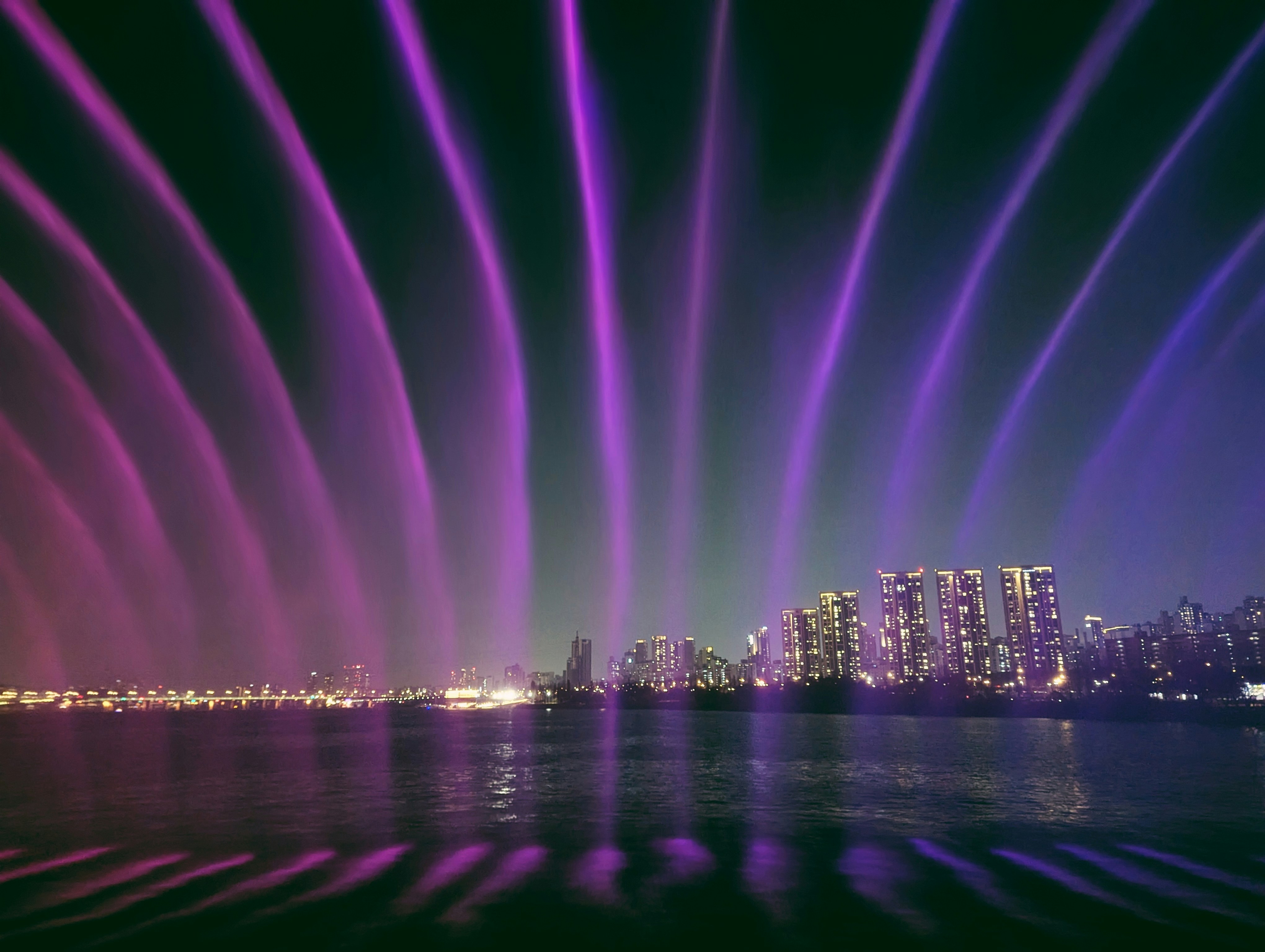 Aurora of the Harbor: Neon Arcs Over a Midnight Skyline
