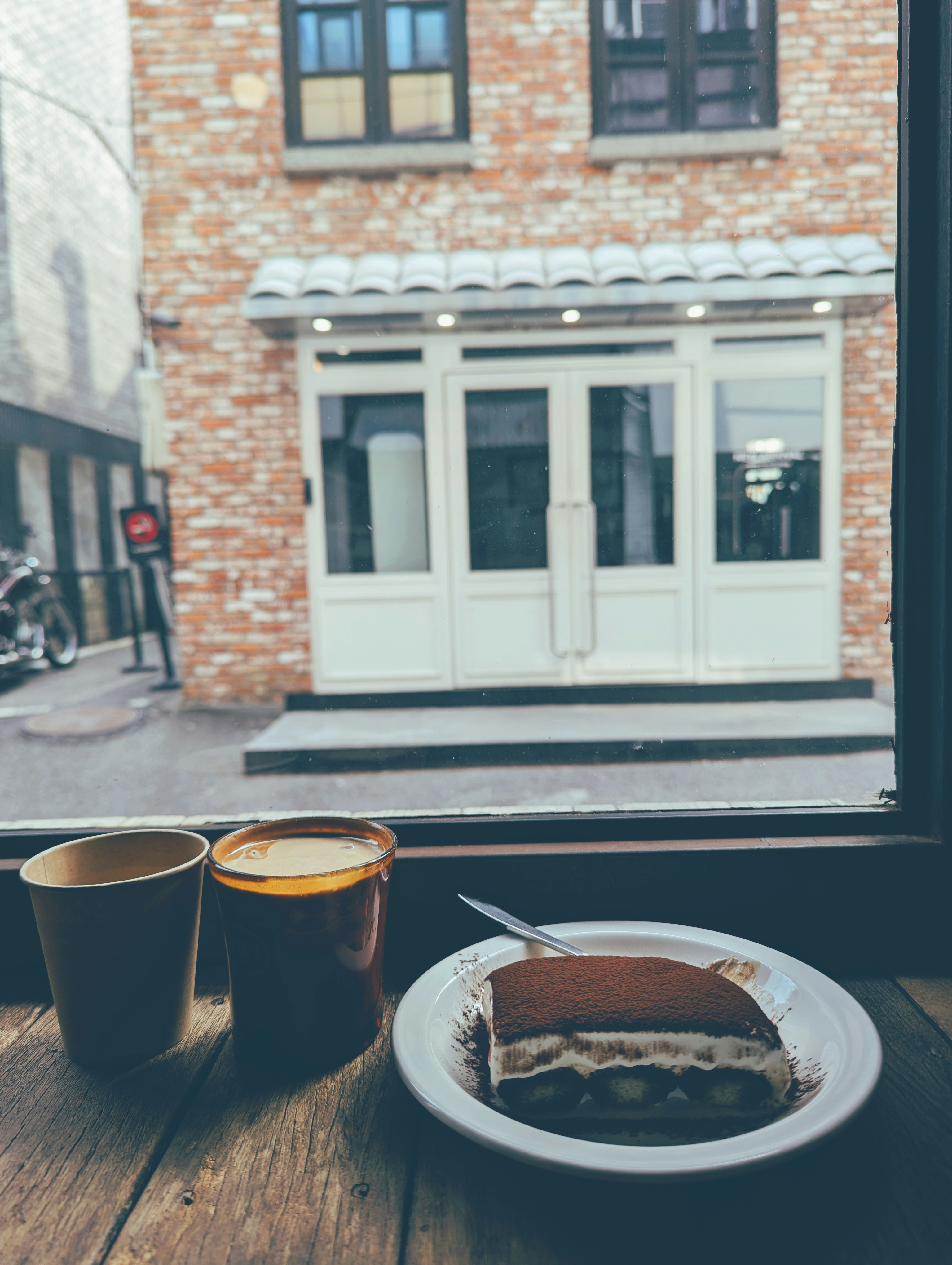 Cafe Window View: Espresso, Tiramisu, and Urban Brick