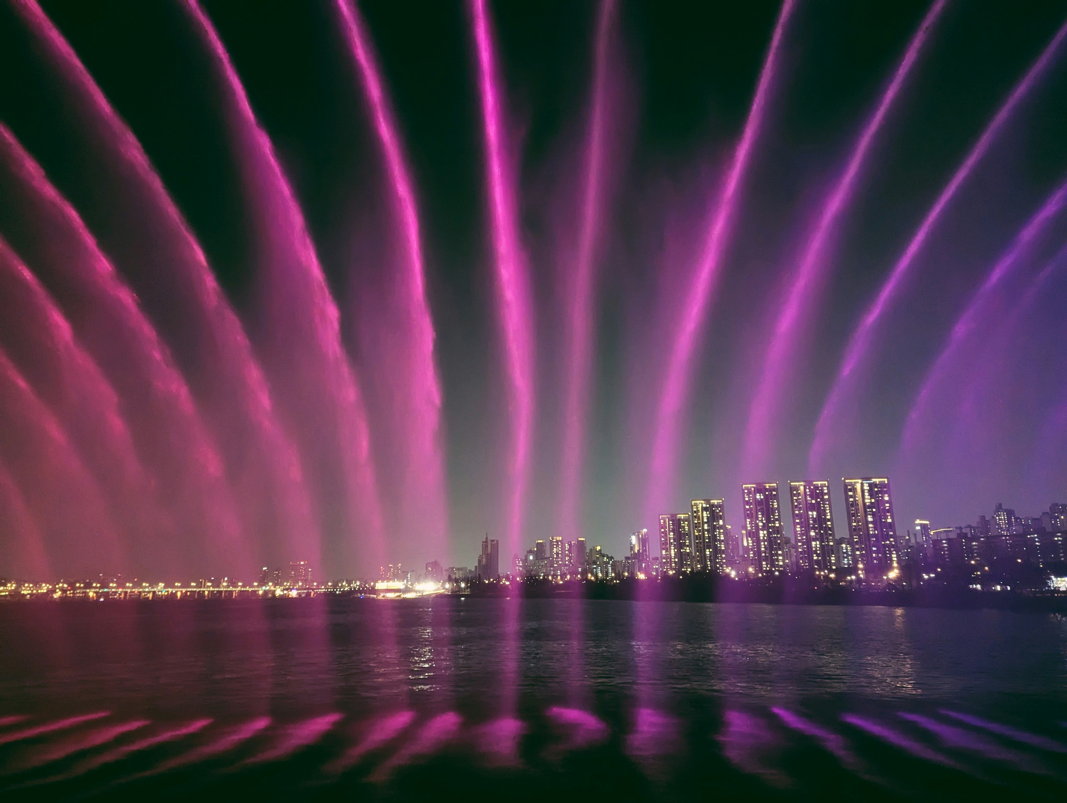 Aurora of Pedestrian Bridges: Neon Arcs over the Waterfront