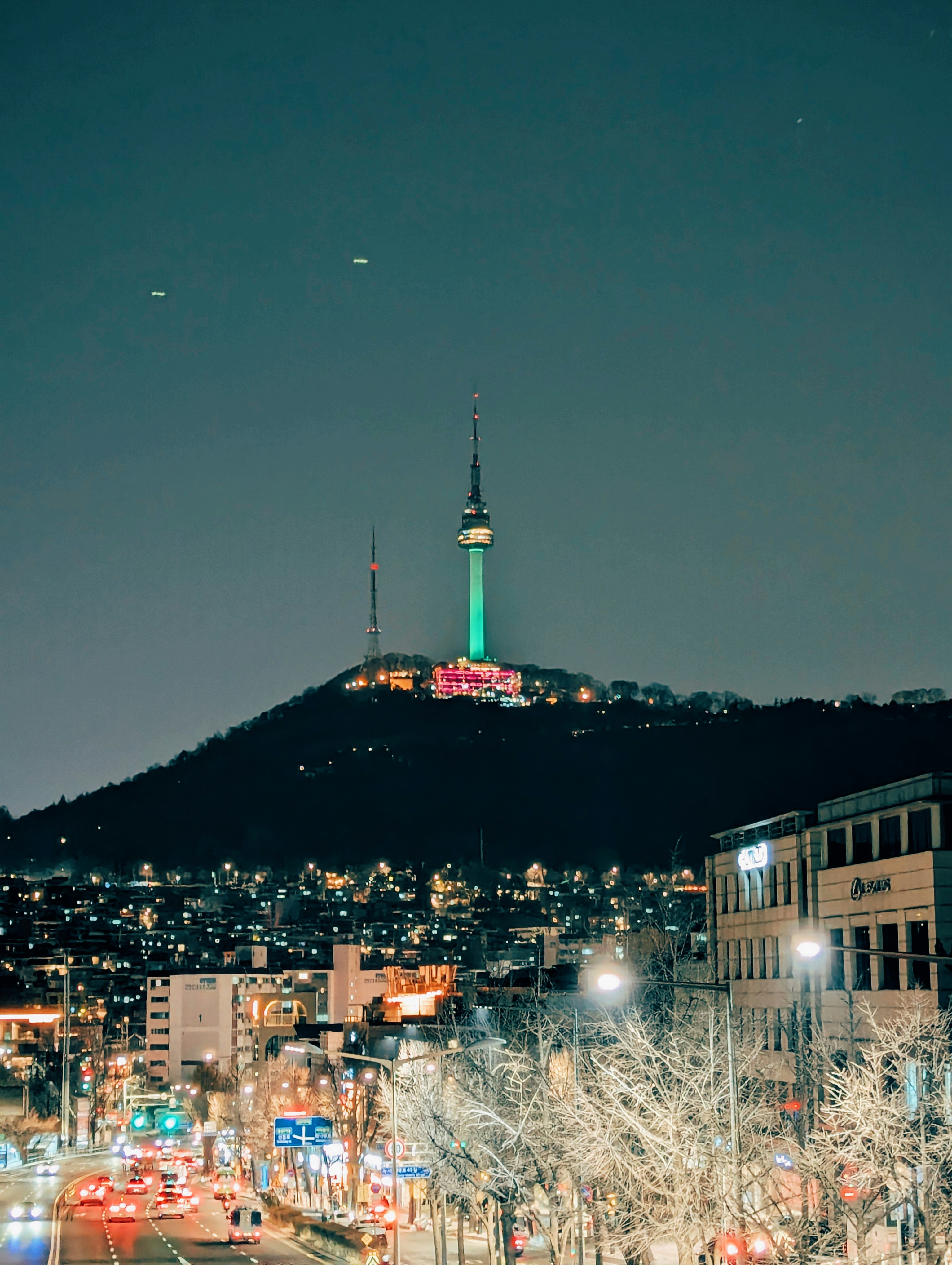 Midnight Peak: Seoul Tower Illuminated Over a City at Dusk