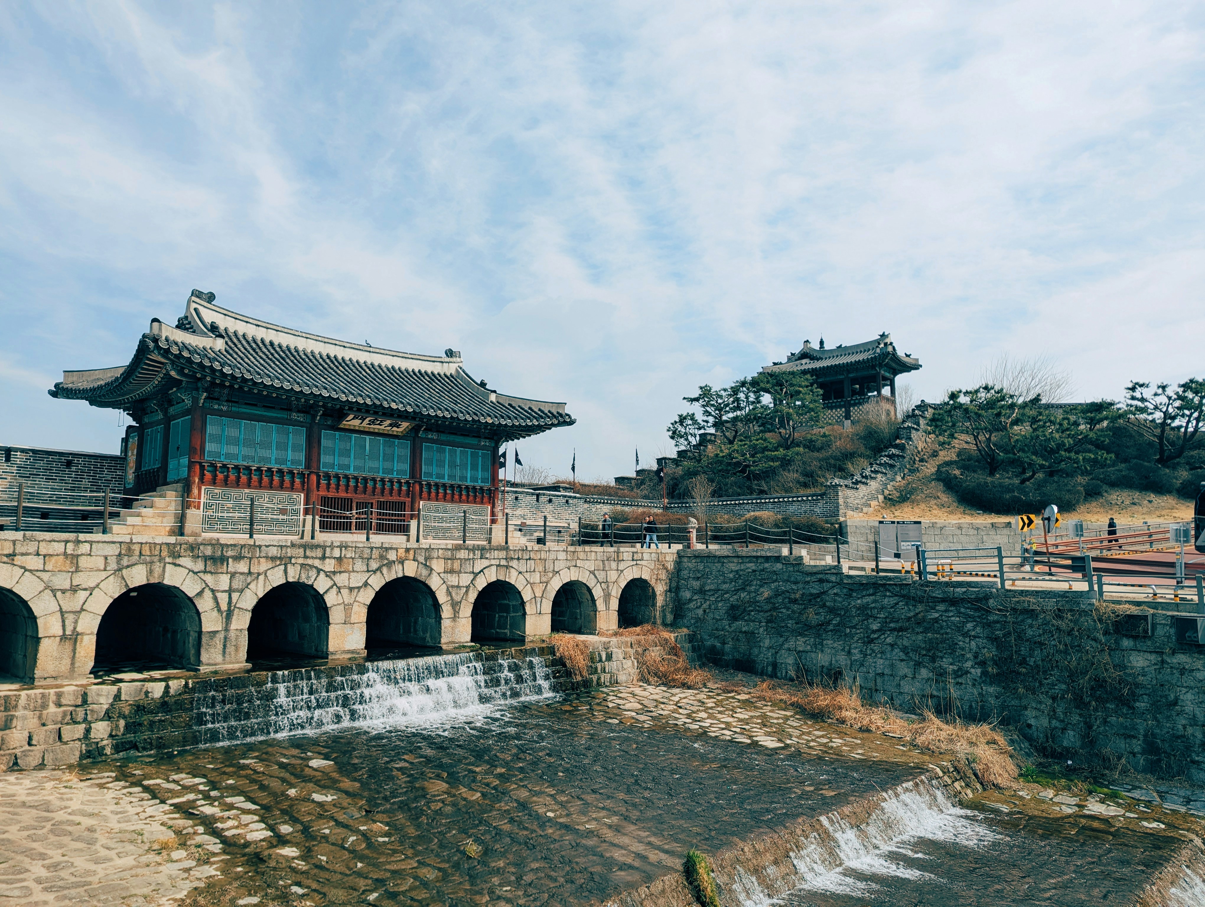 Stone Bridge and pavilions over a cascading stream at a historic fortress