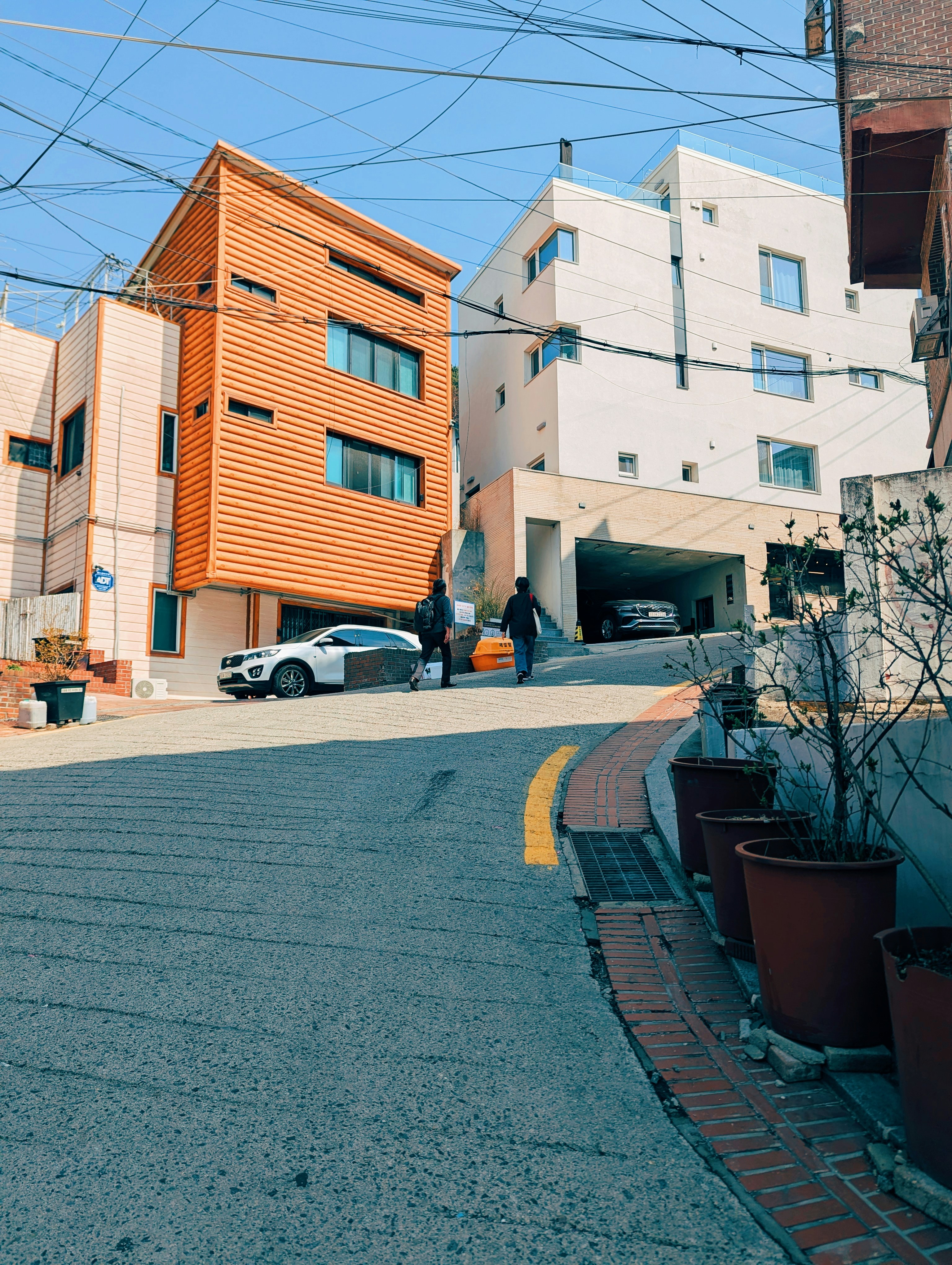 Urban Tilt: A Bright Orange Facade Anchors a Quiet Street
