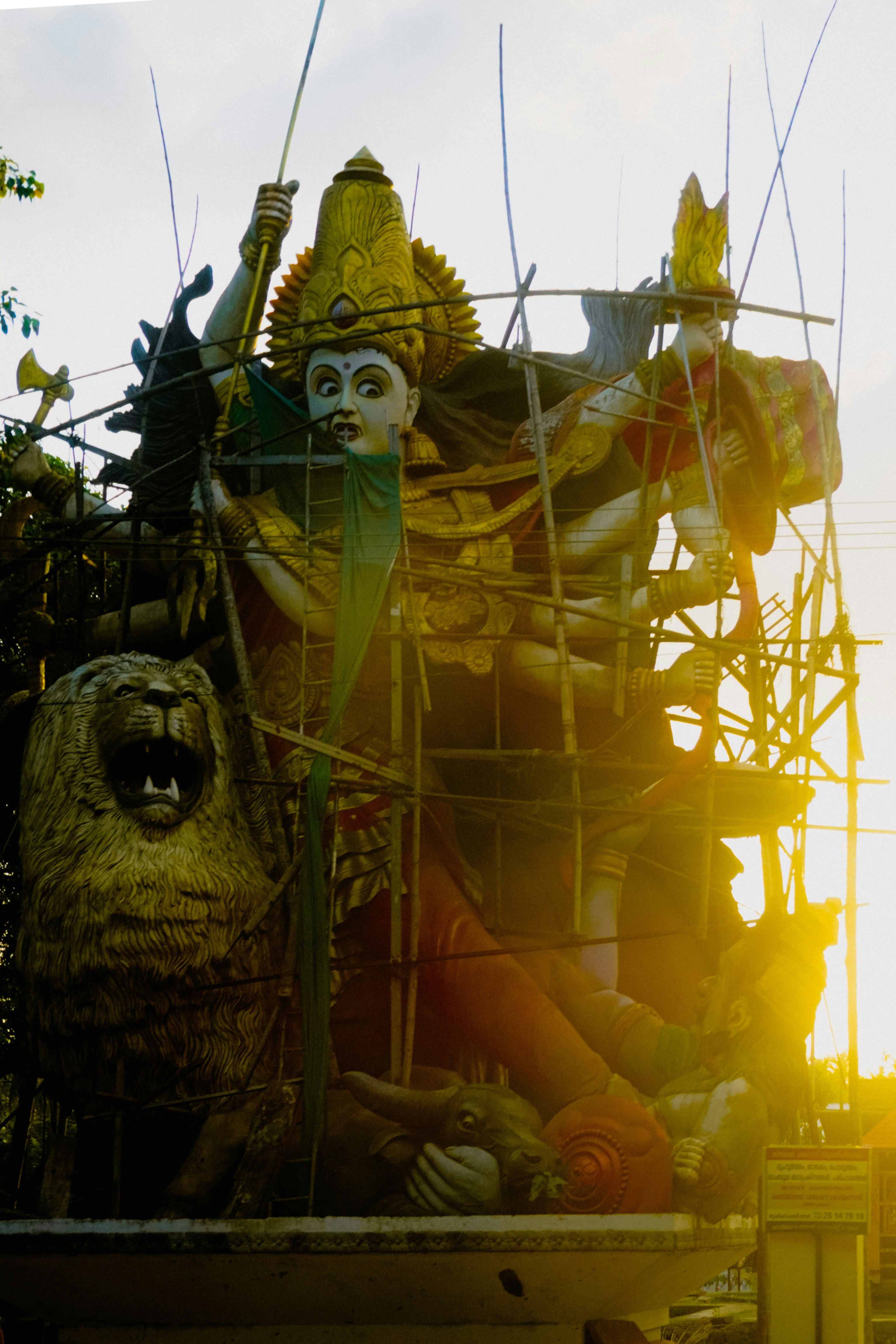 Statue Under Construction: A Mythic Scene Bathed in Sunset Glow