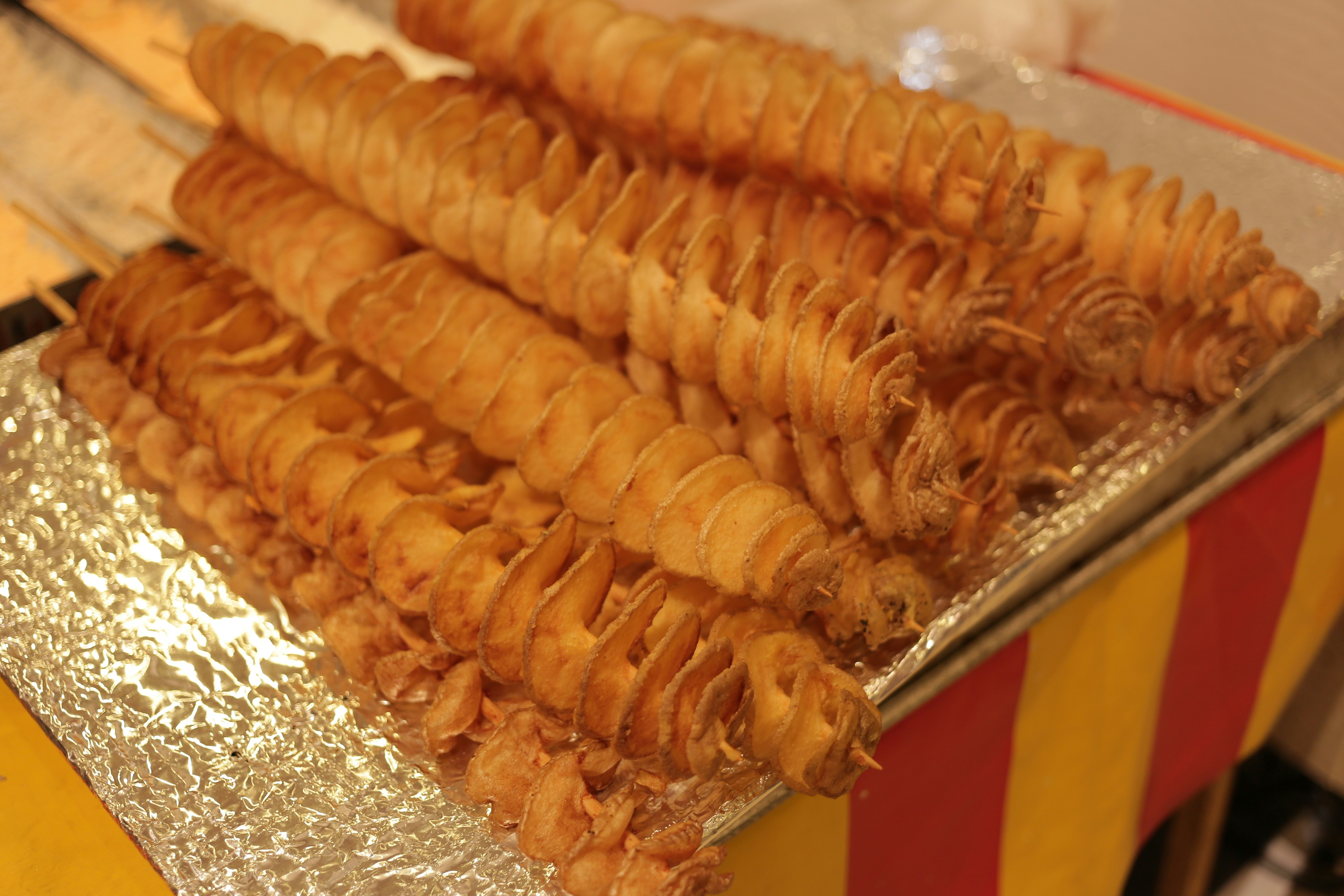 Crisped Spirals on a Shiny Tray: Golden Sticks at a Street Market Stall