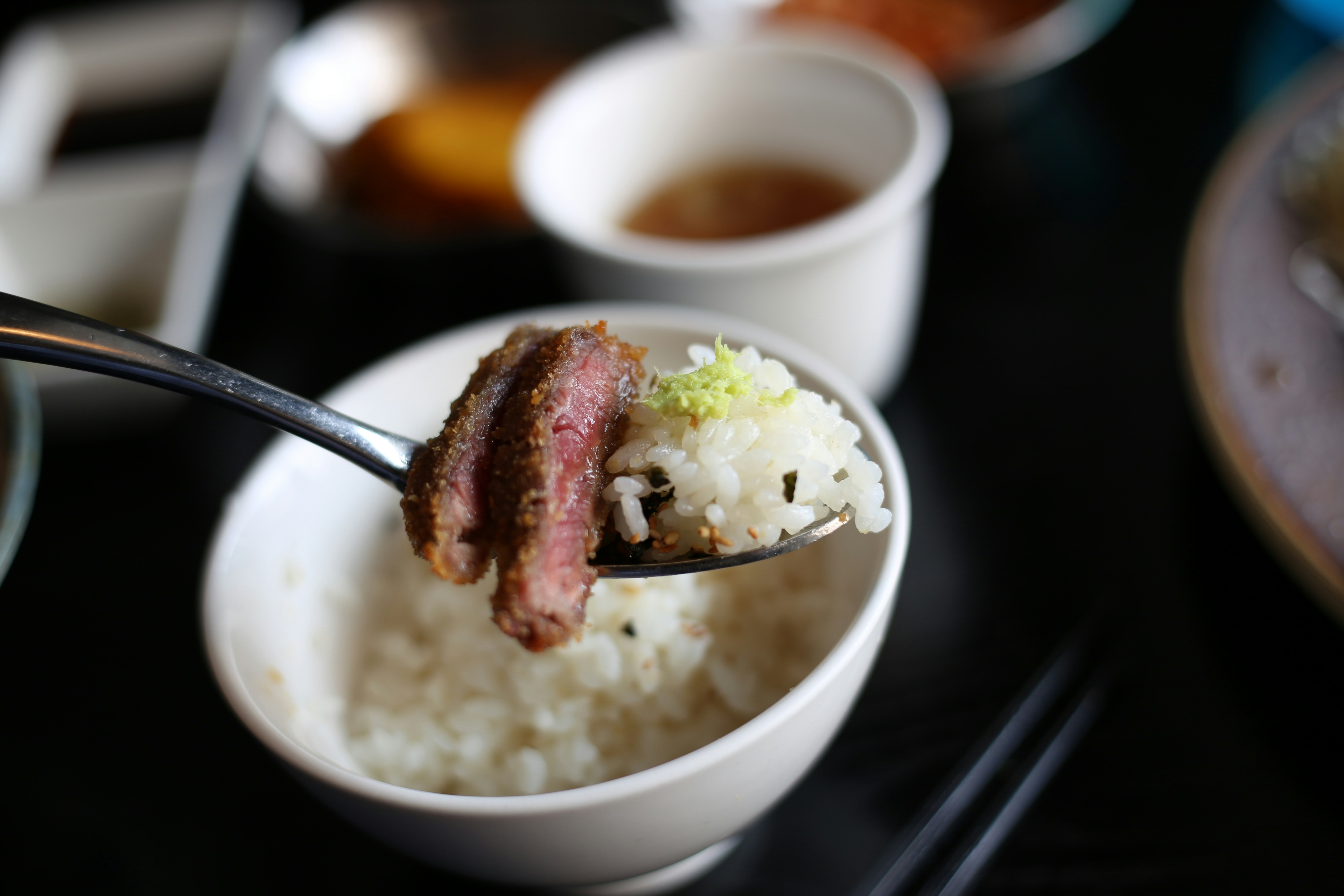 Tender Bite: A Slice of Garlic-Black Pepper Steak over Steaming Rice