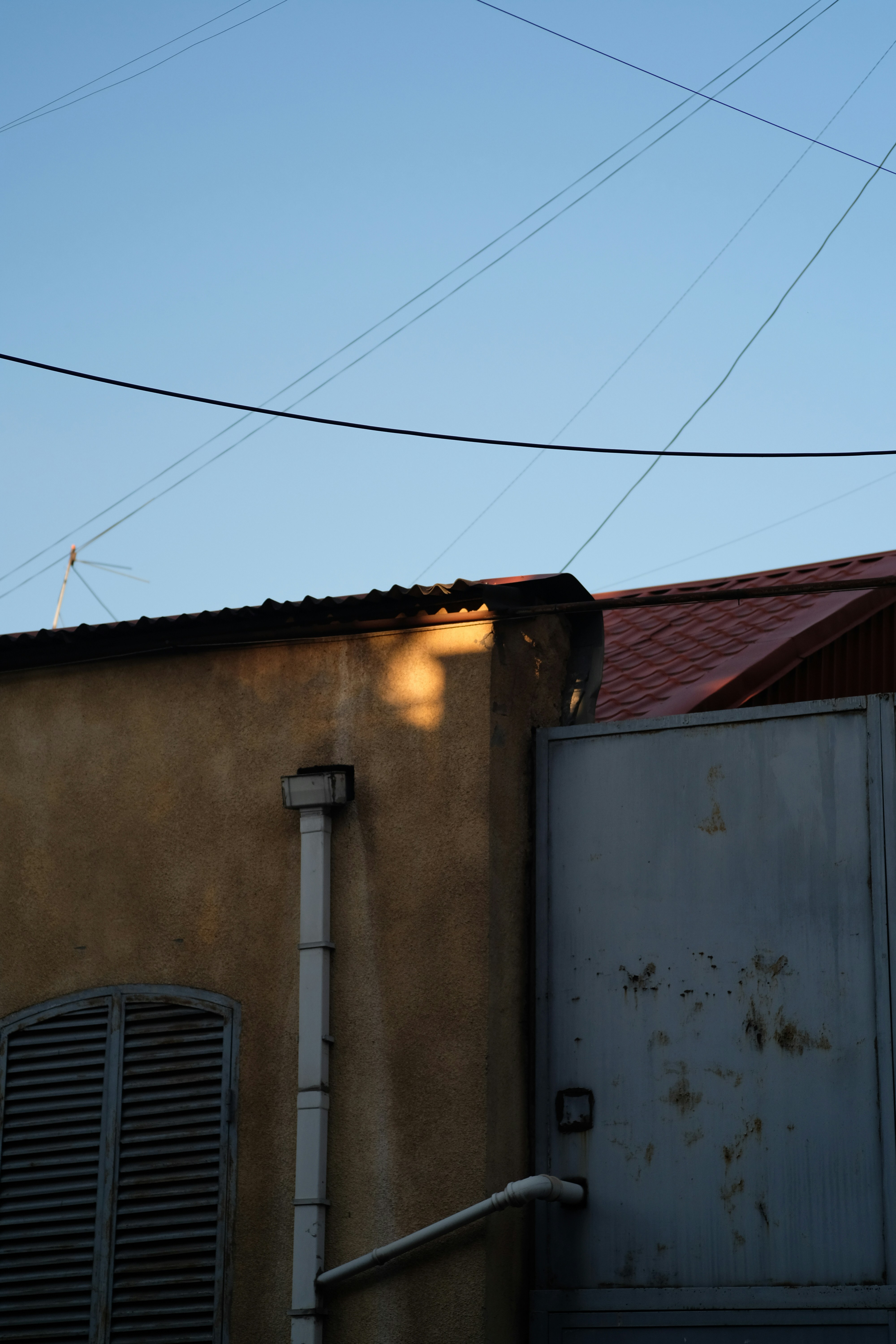 Sunlit Roofline and Utility Details in Quiet Encroachment
