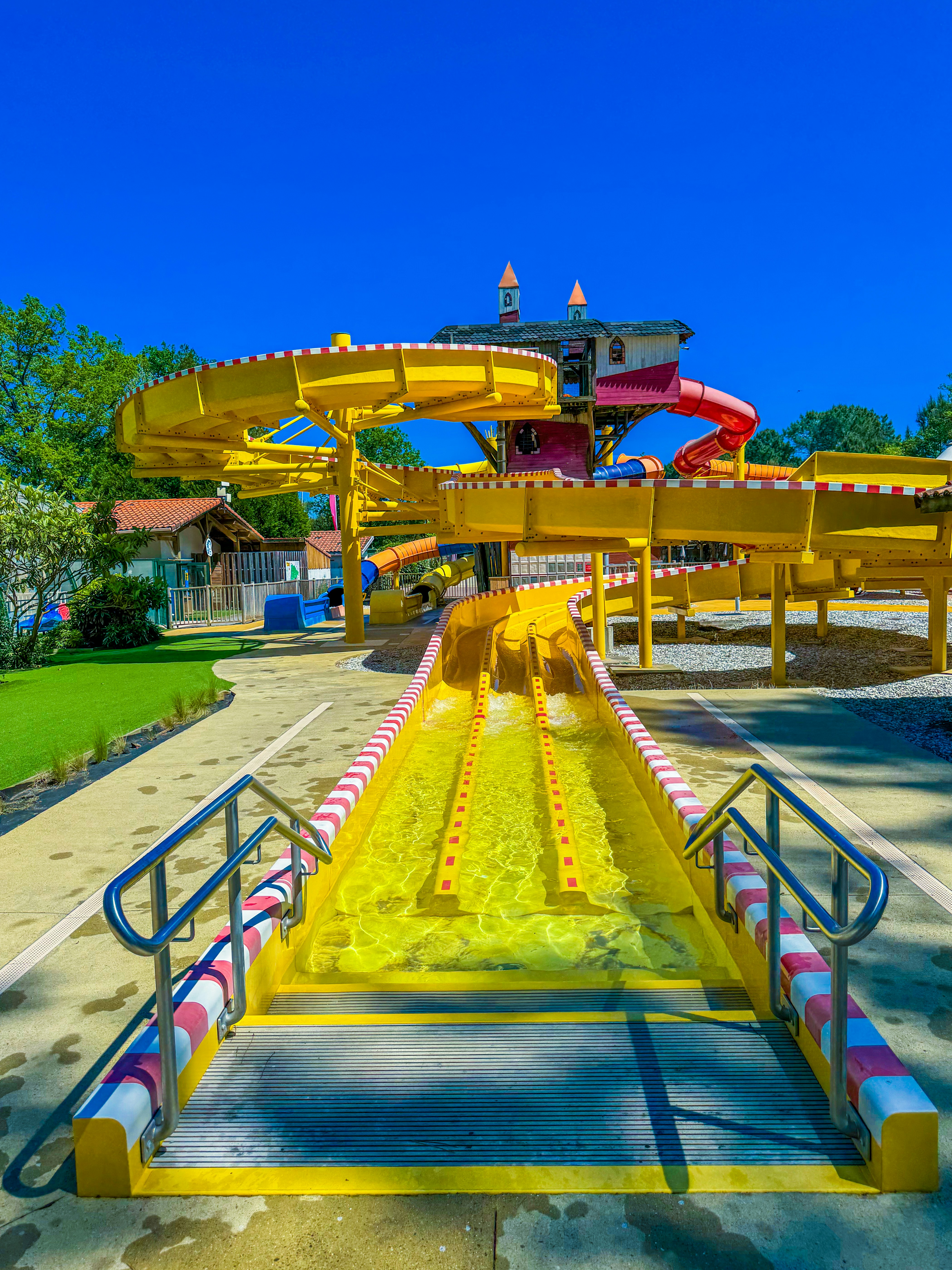 Yellow Currents: A Spiraling Water Ride Dives Toward the Bright Sky