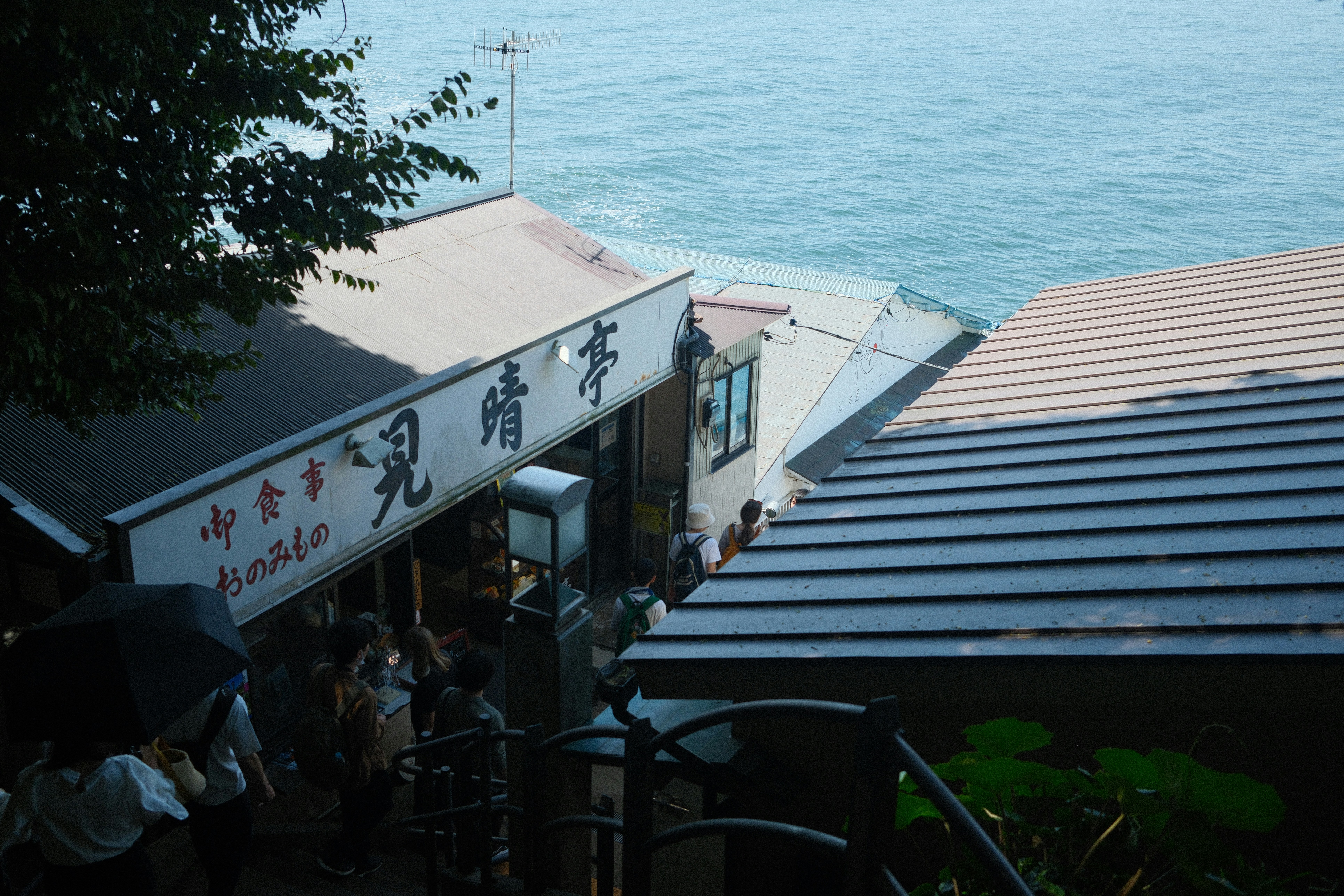 Lakeside Staircase Café Under Blue-Tiled Roofs
