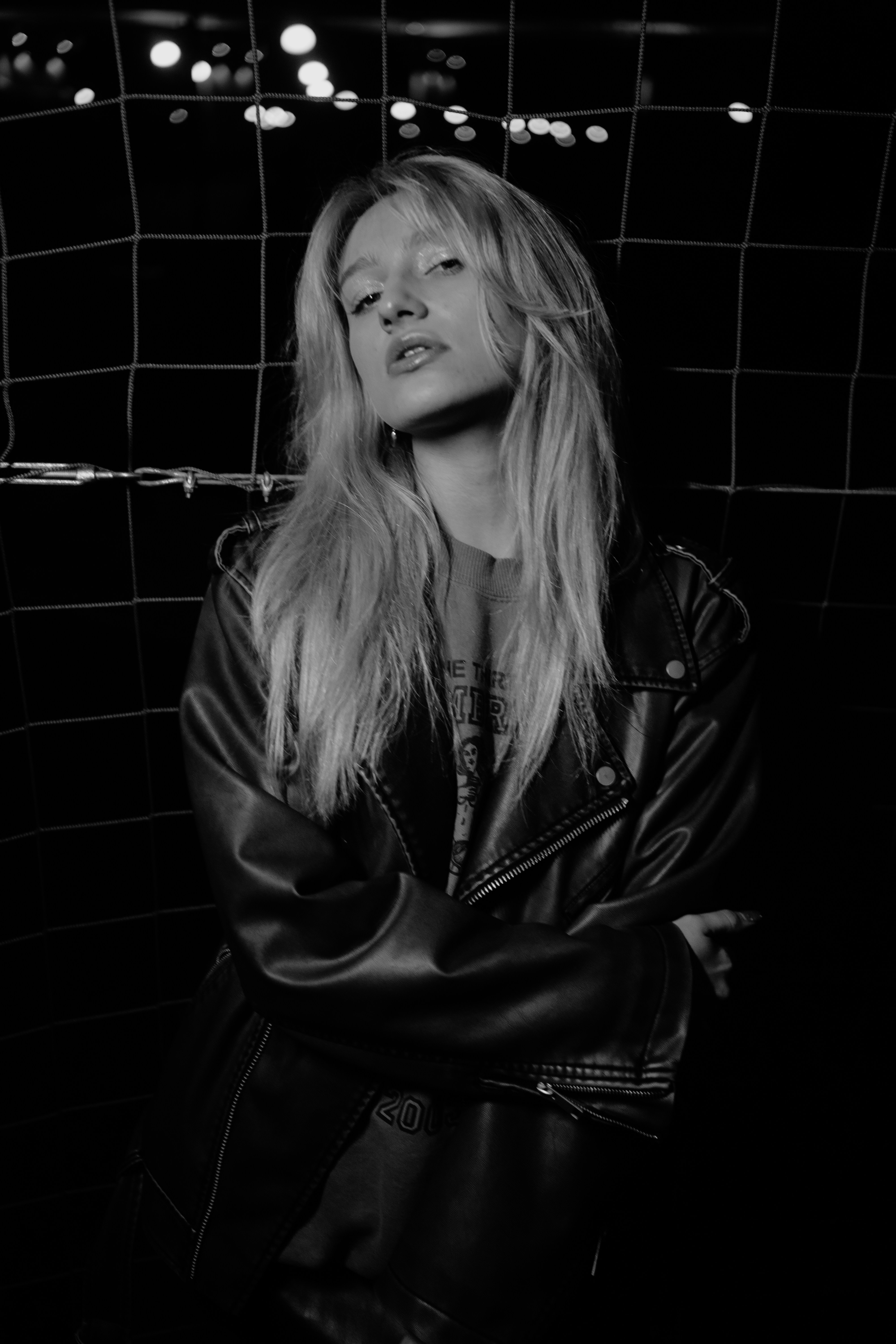 Midnight Neon: A Leathered Poise under Wiregrid Lights