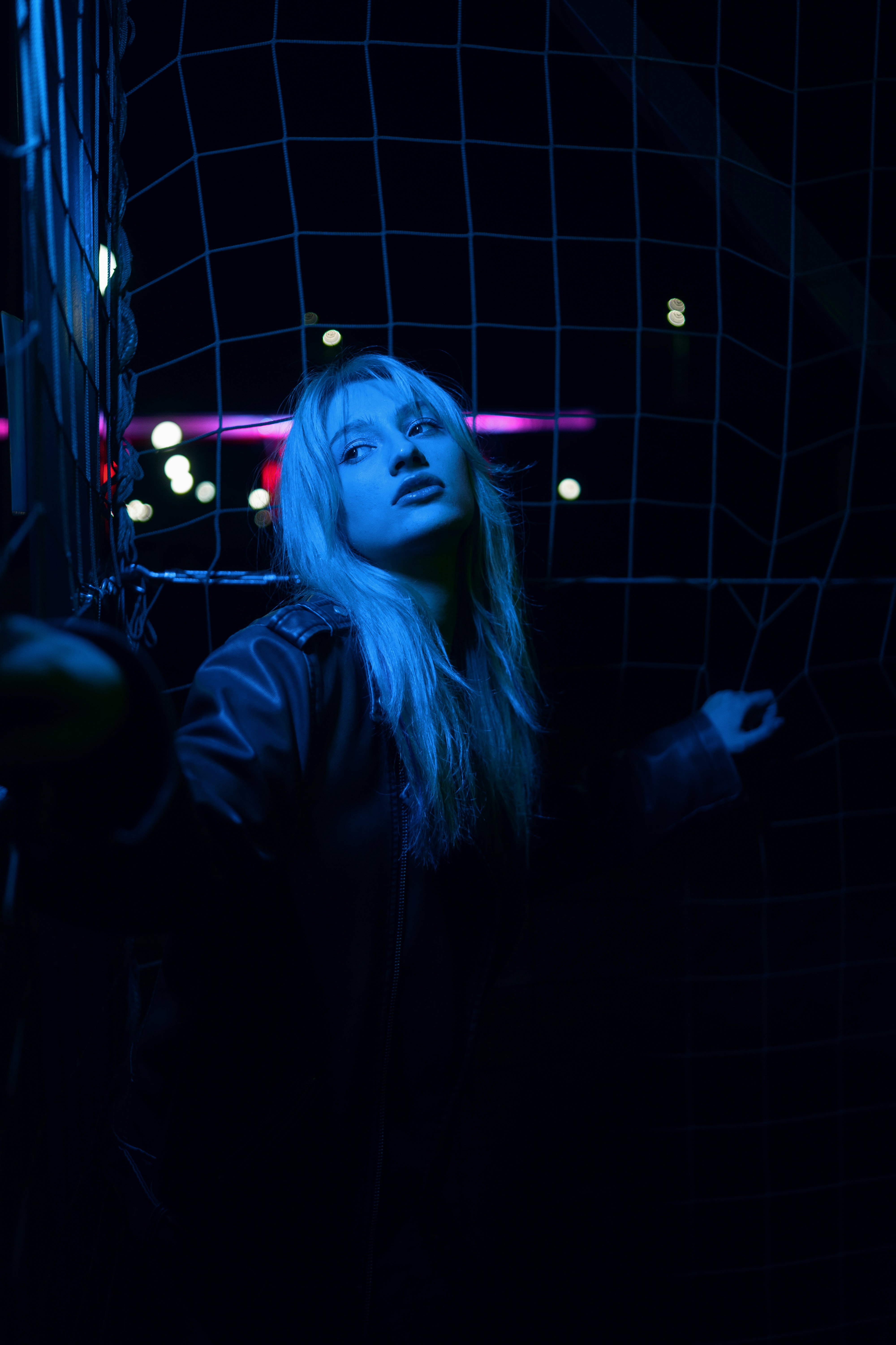 Neon Night Gaze Behind a Net