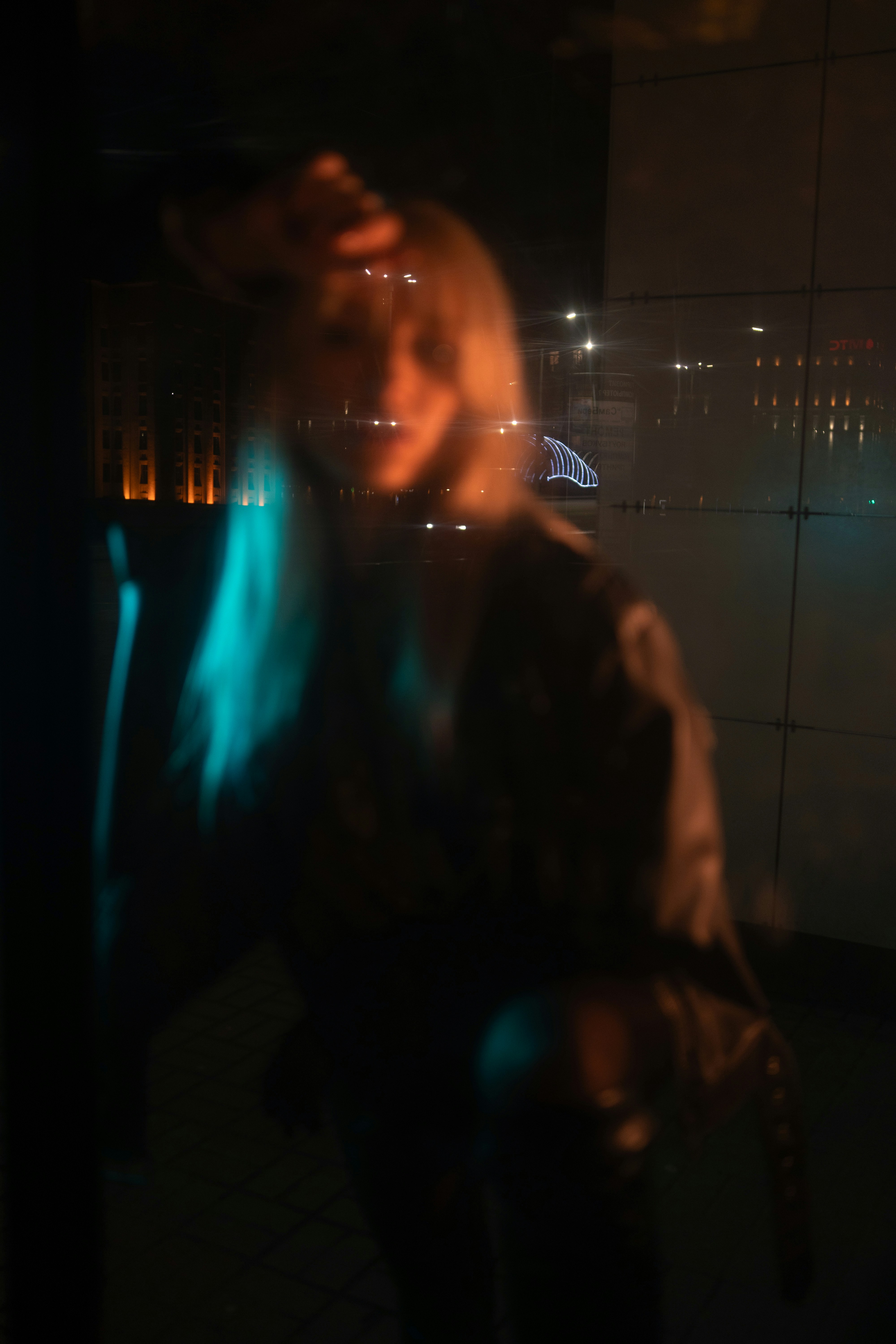 Neon Blur: A Night Portrait Behind Glass